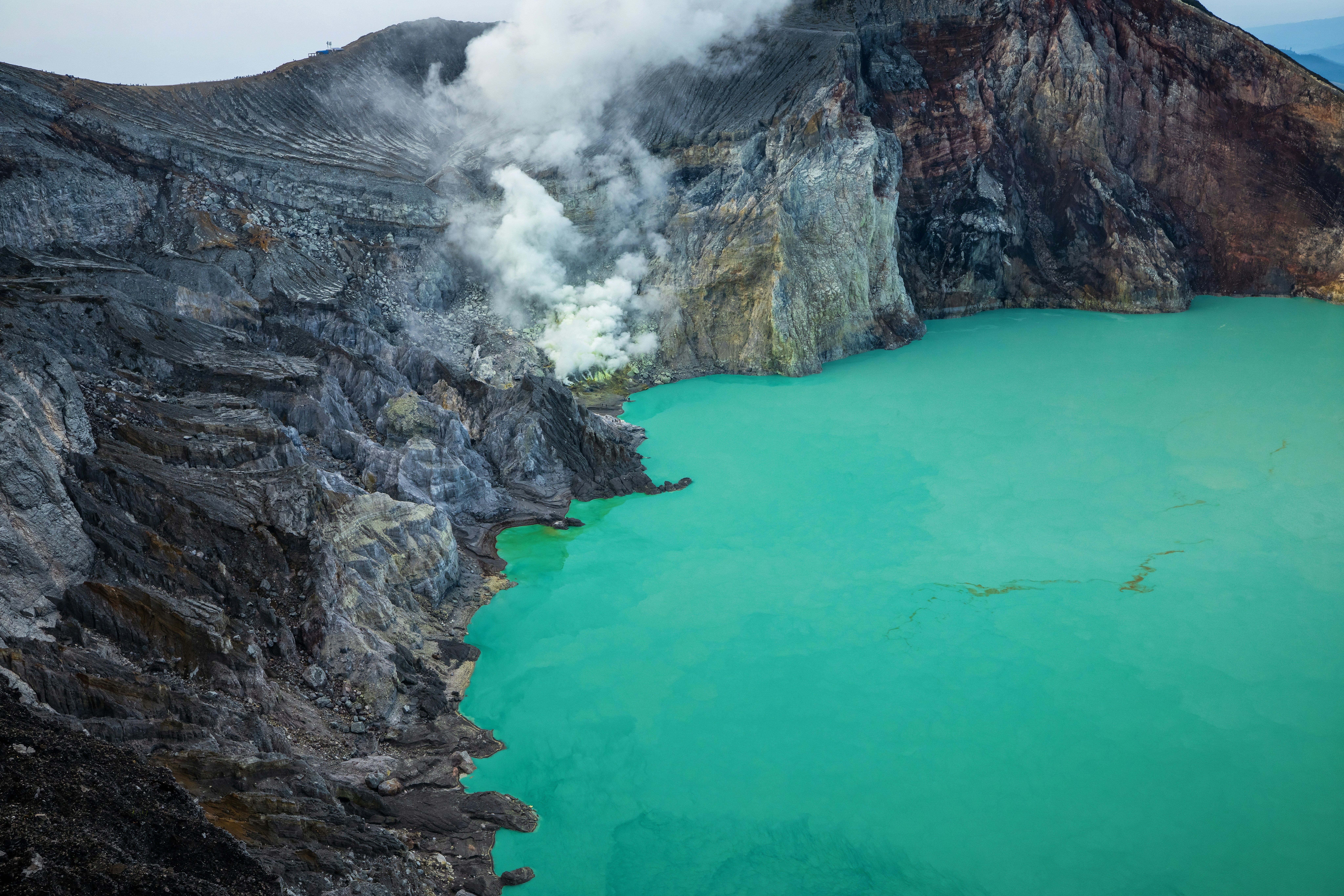 Emerald Crater: A Turquoise Confluence of Smoke and Rock