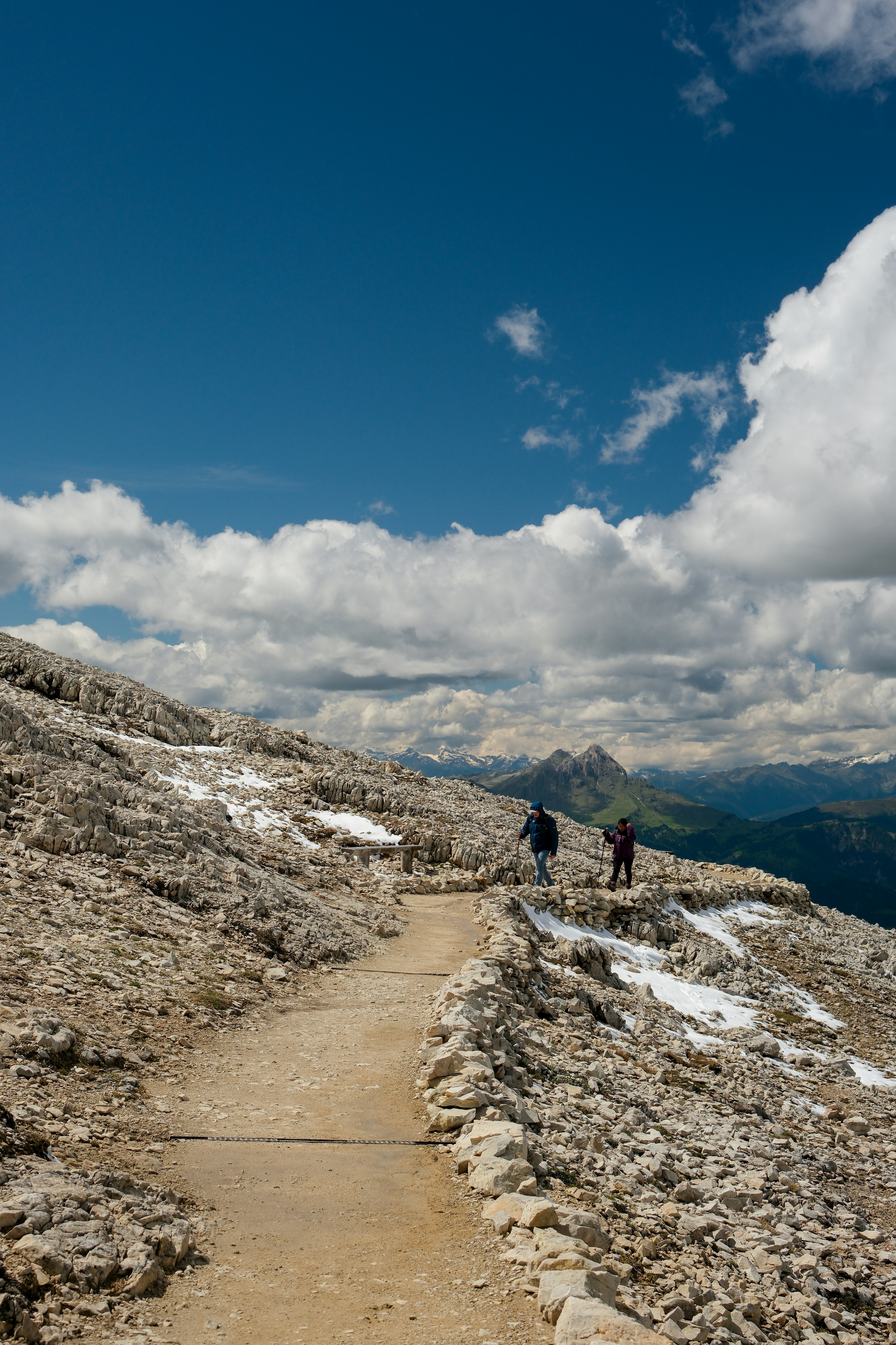 High Ridge Crossing: Hikers on a Granite Path Over the Quiet Mountain