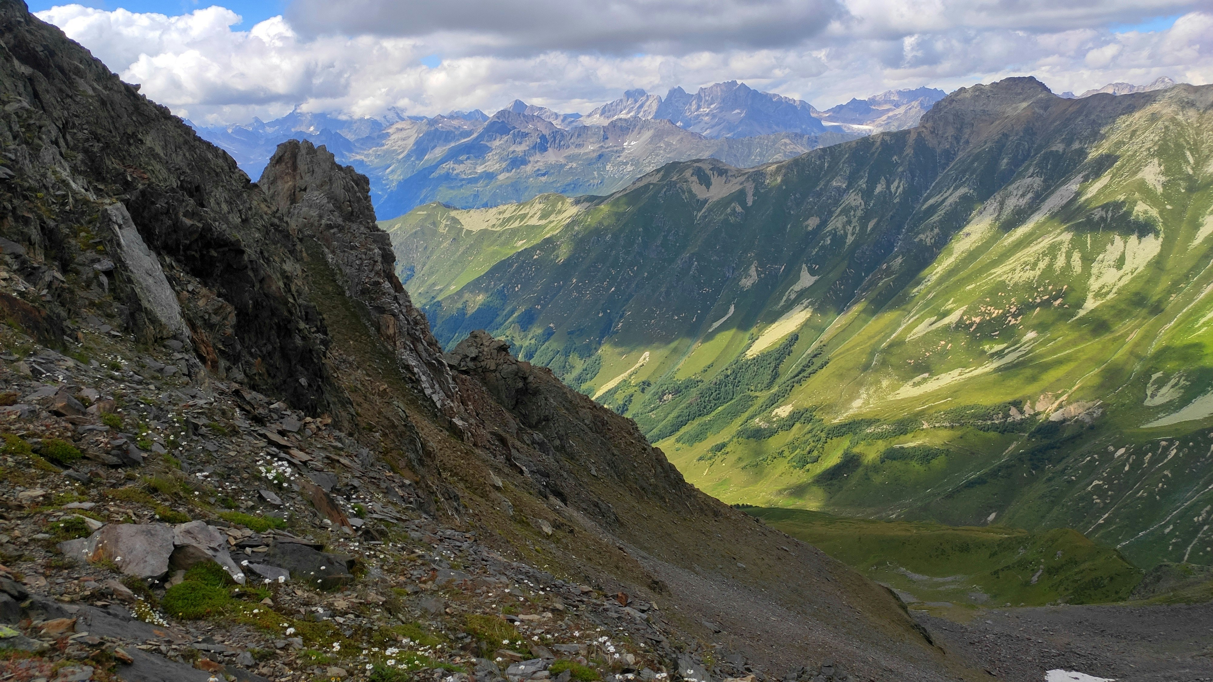 Ridgeward Vista: Green Valleys Press Against Snow-Capped Peaks