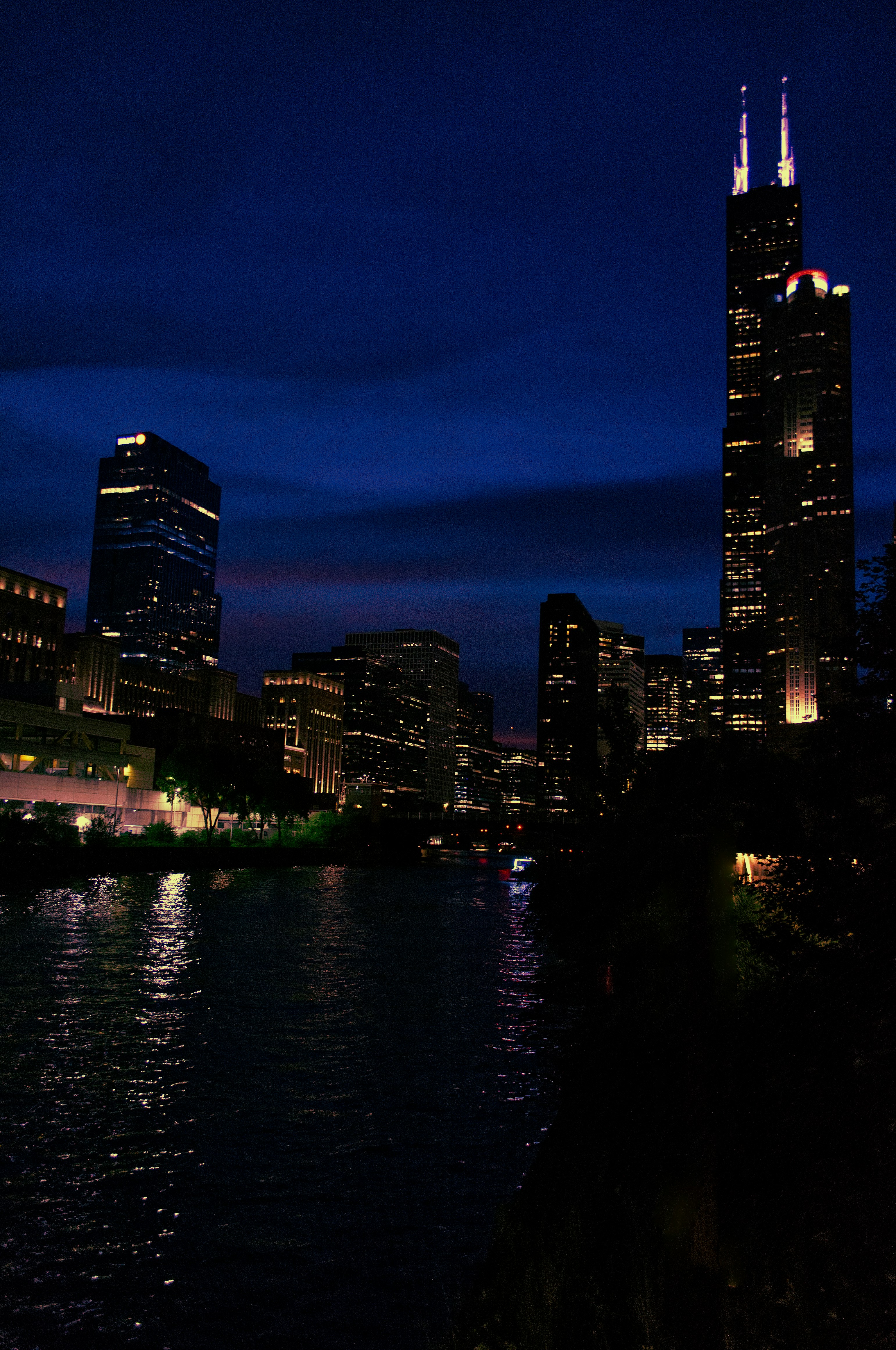 Nightfall Over Chicago River: A Silhouette of Skyscrapers and Reflections