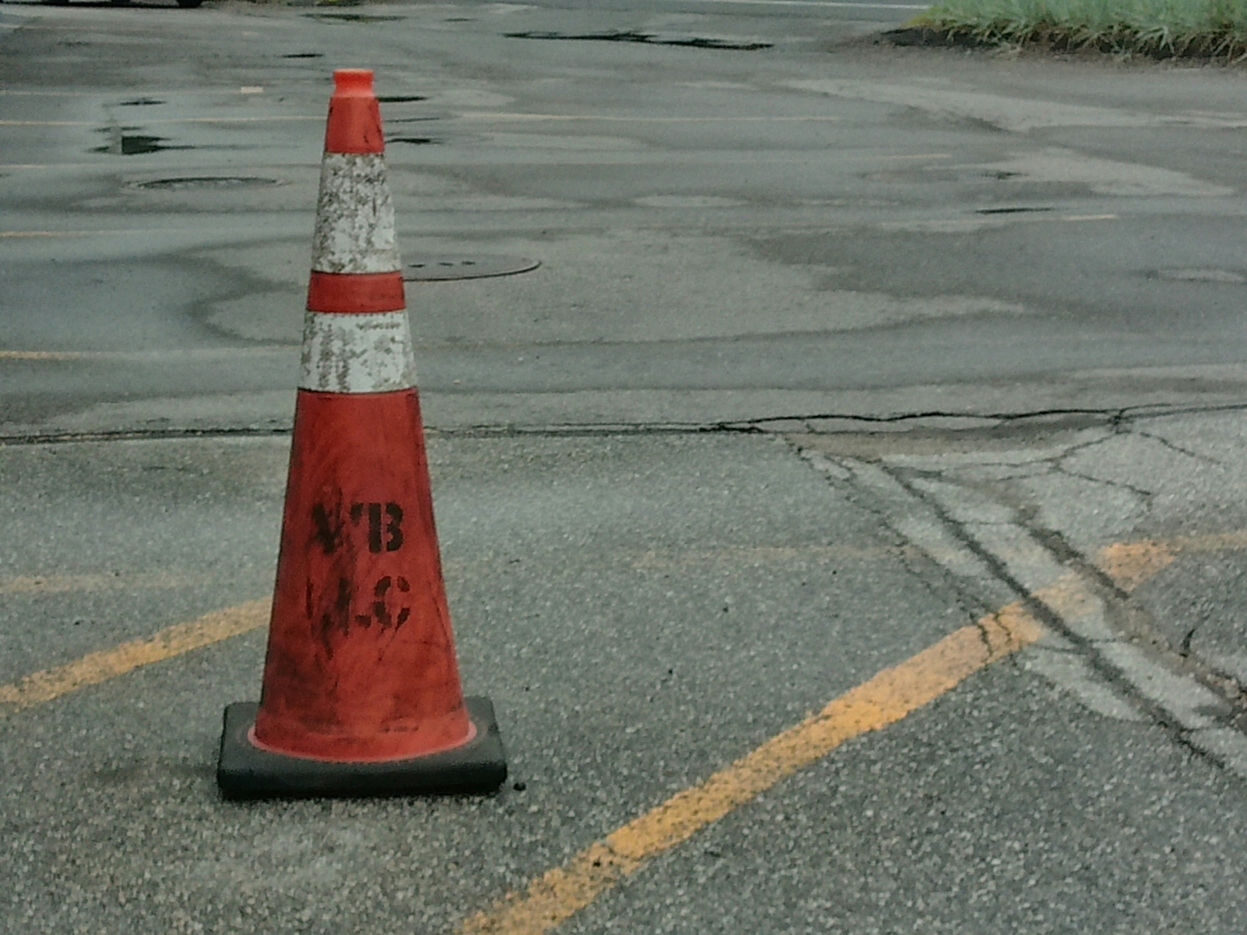 Cone in a Parking Lot: Worn Safety Cues in Harsh Light