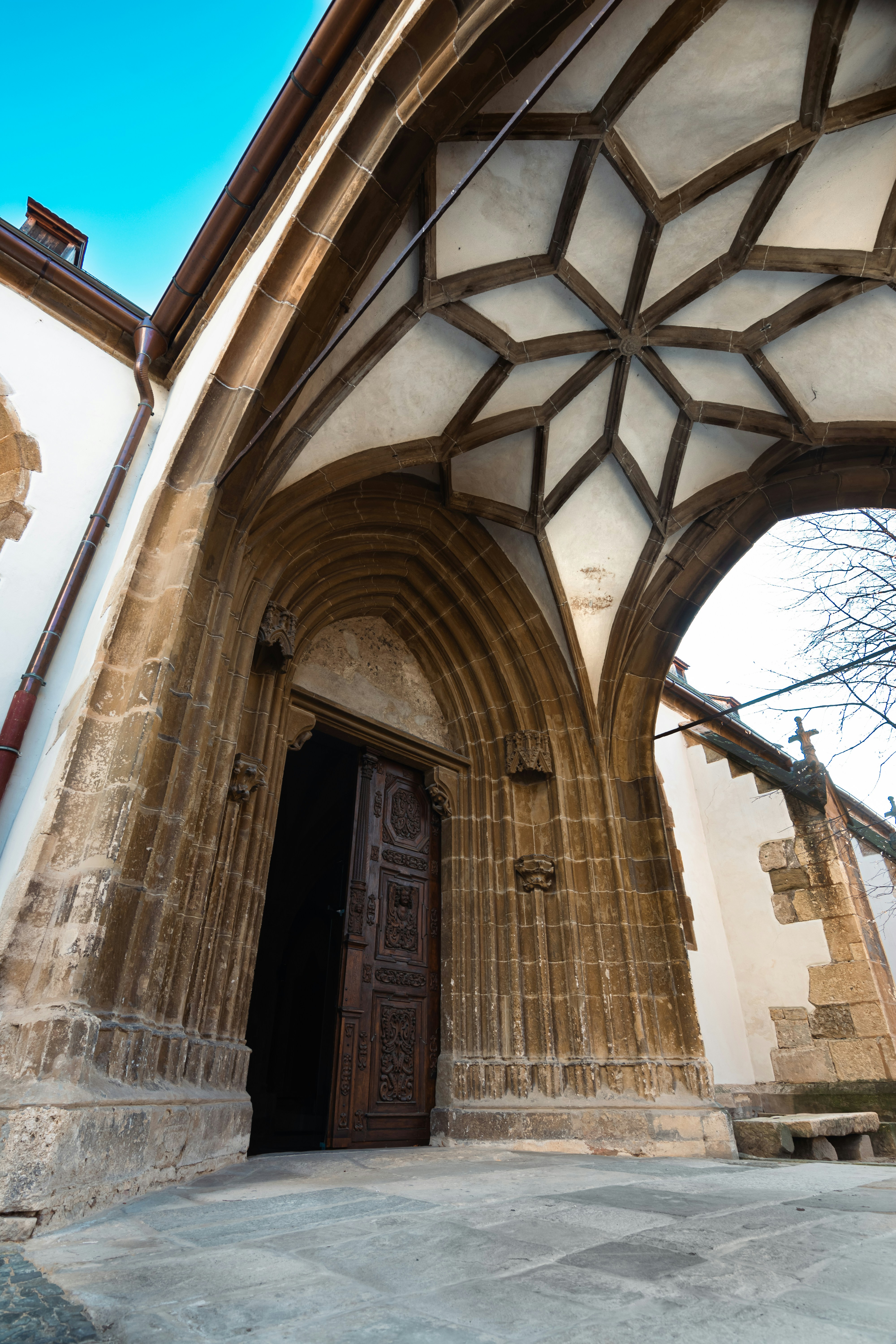 Gothic Portal: Carved Archway Receiving Light from a Clear Sky