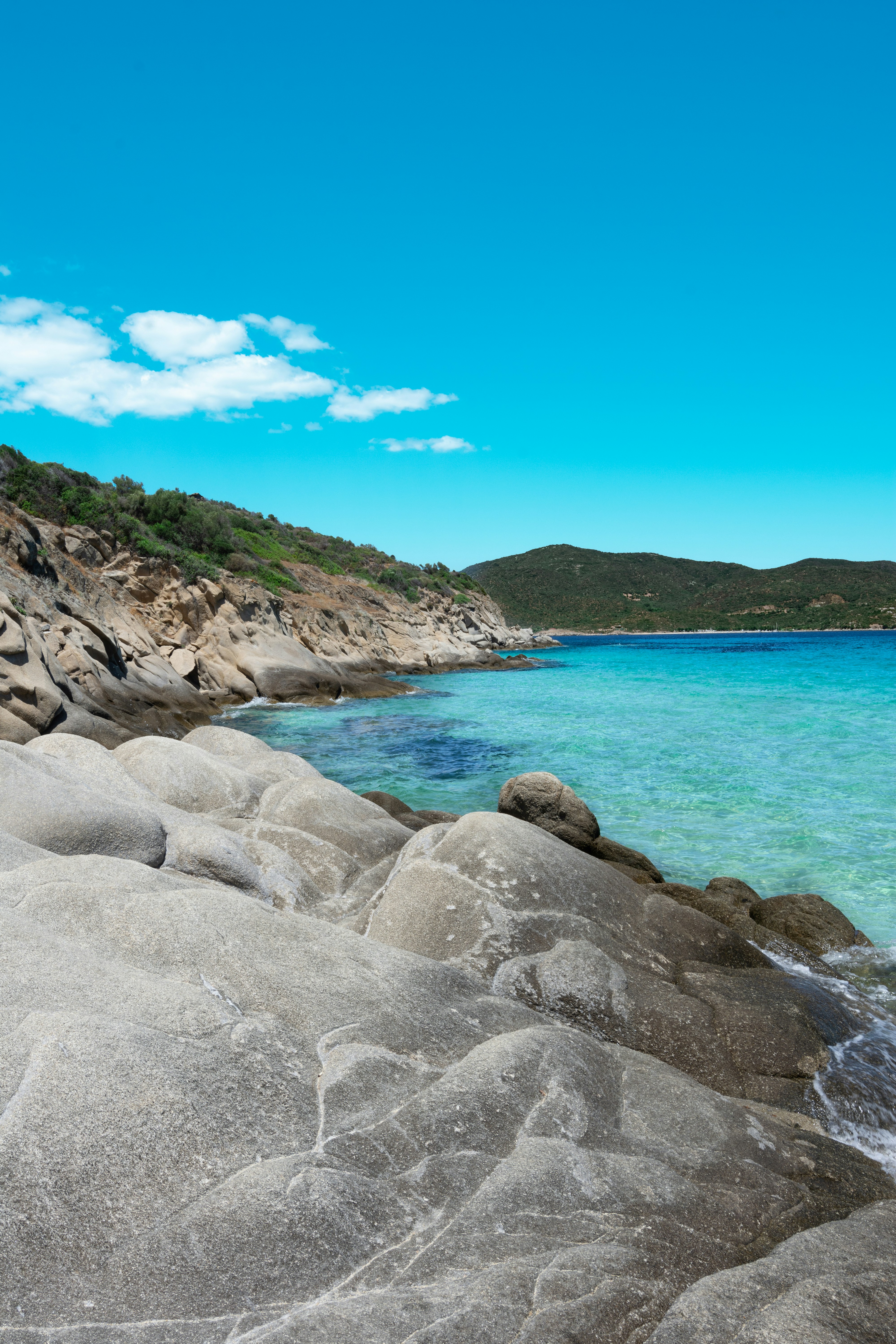 Coastal Granite: Sunlit Rocks Meeting Turquoise Sea