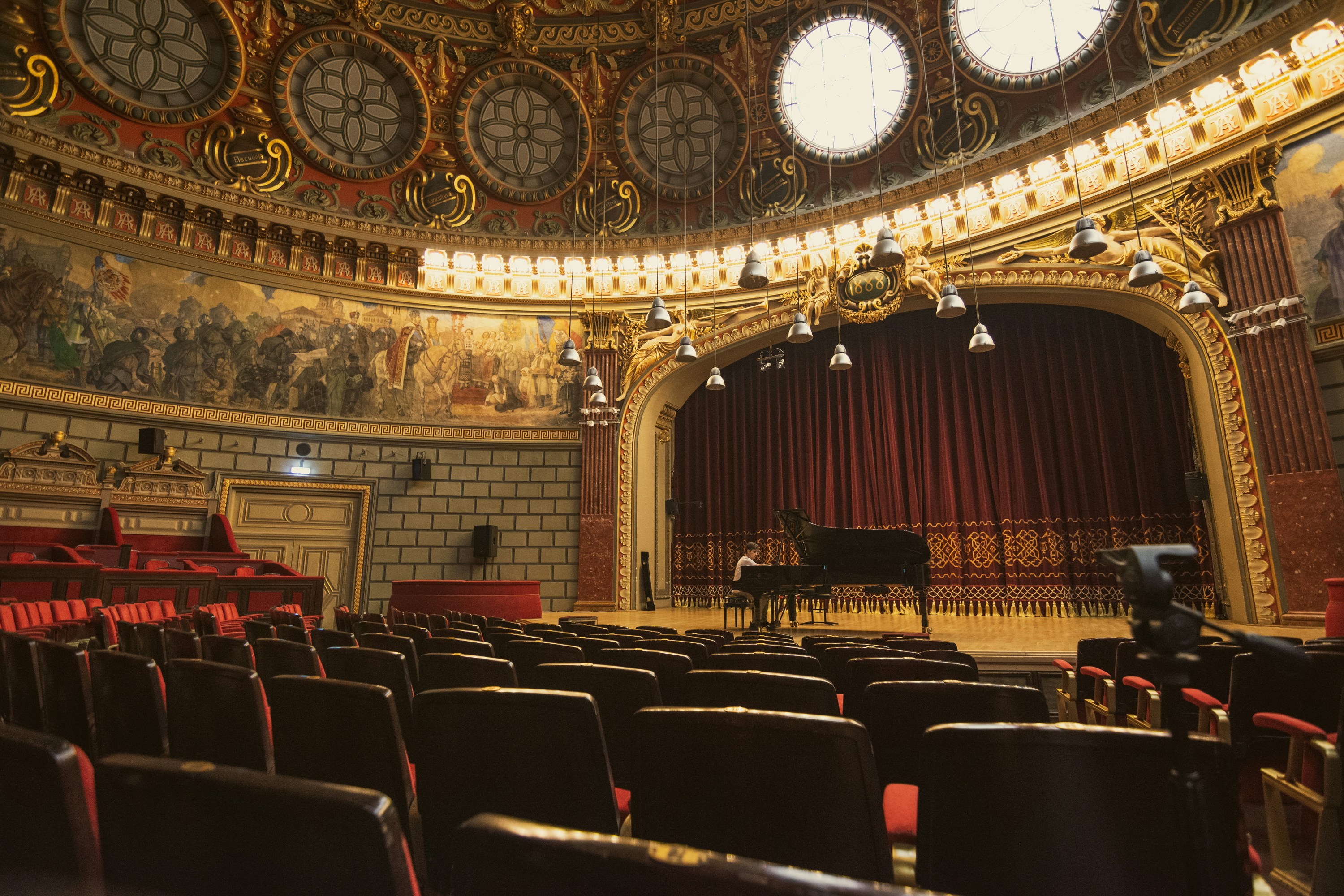 Ornate Hallway to the Spotlight: An Empty Concert Stage in Warm Parlor Light