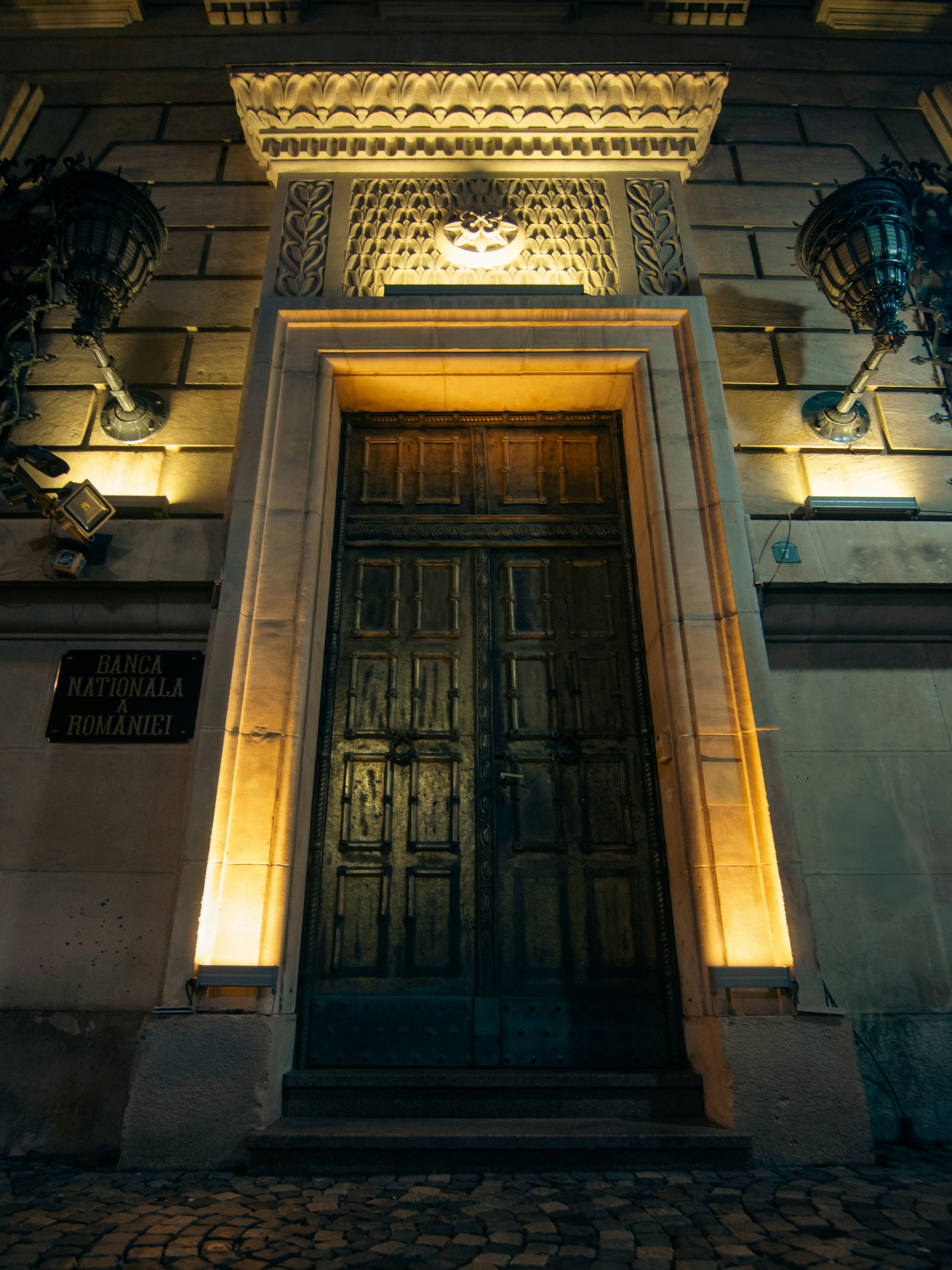 Luminescent Portal: An Ancient Door Framed by Night Lights