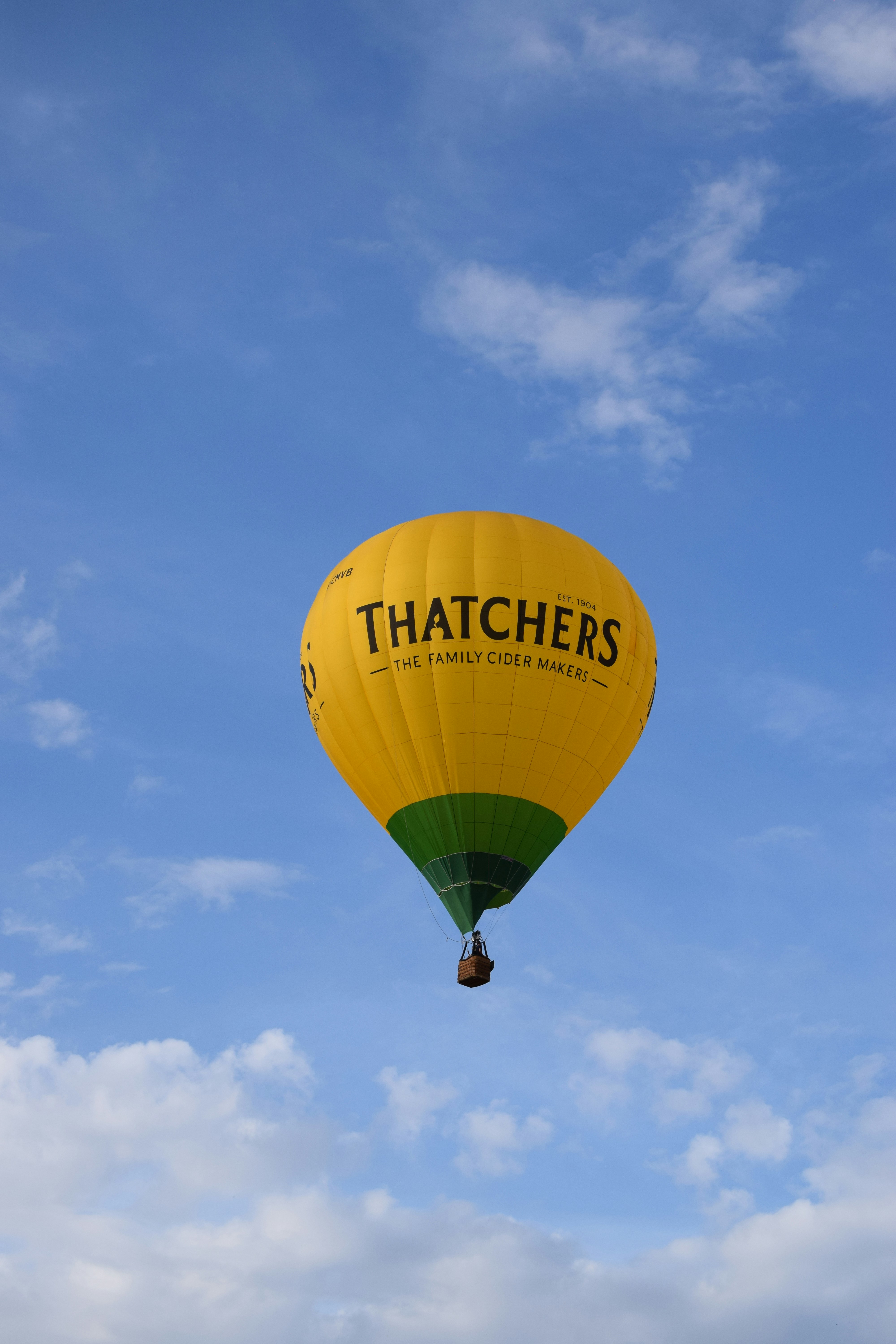 Yellow Lantern Drifter: A Thatchers Balloon in Quiet Sky