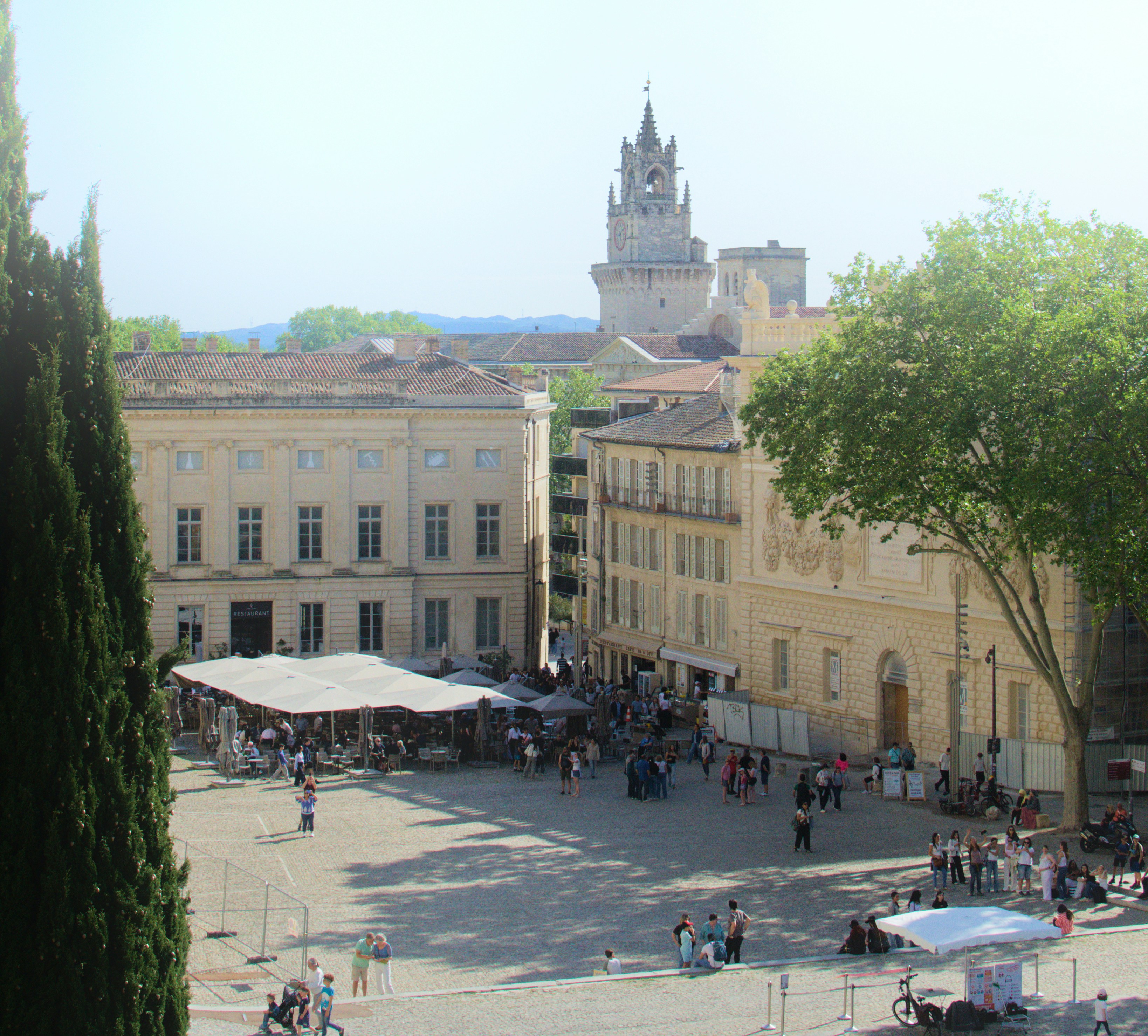 Sunlit Terrace: A European town square Under a Clock Tower