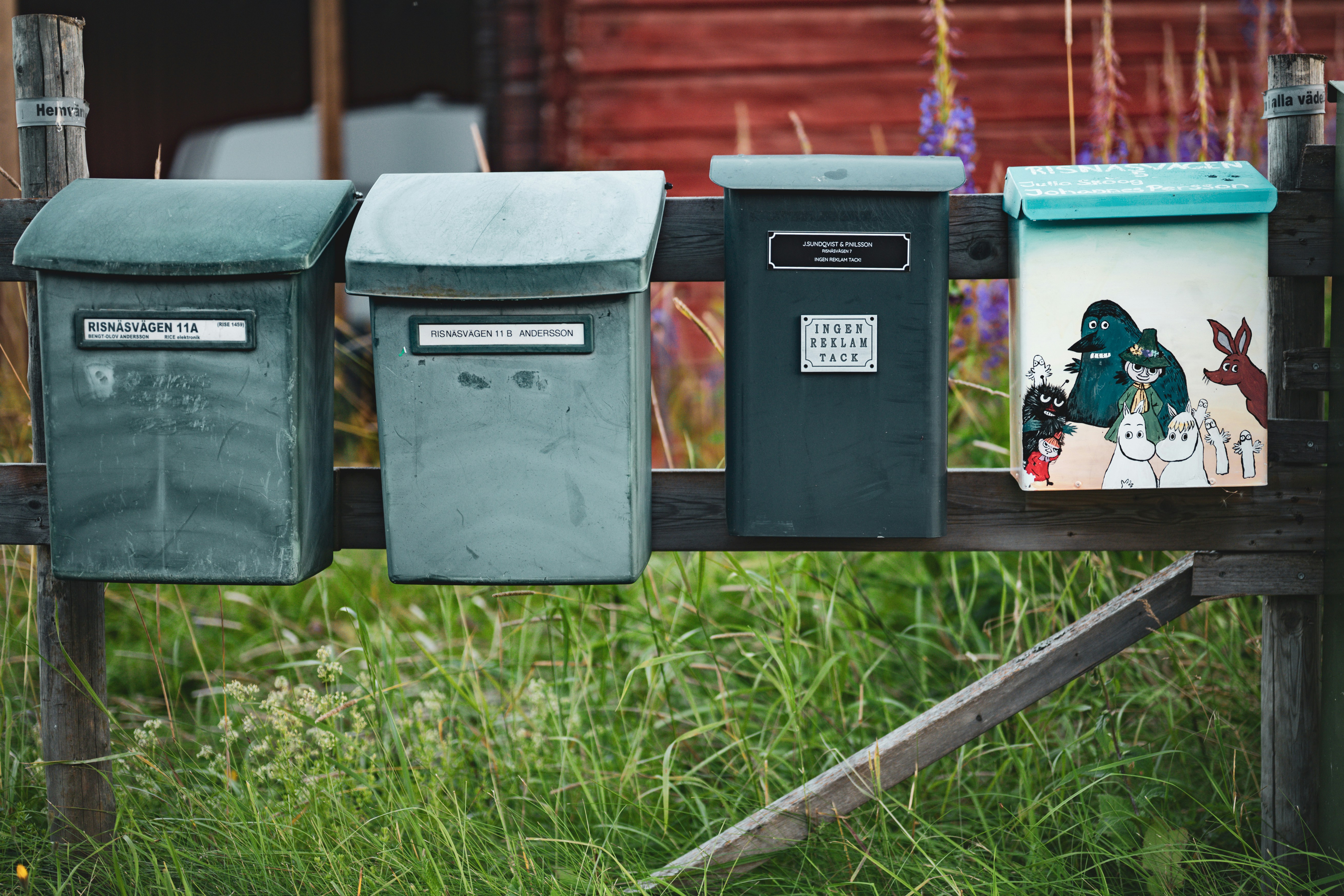 Row of Mailboxes in Quiet Yard, Two-Tone Blues with a Painted Corner