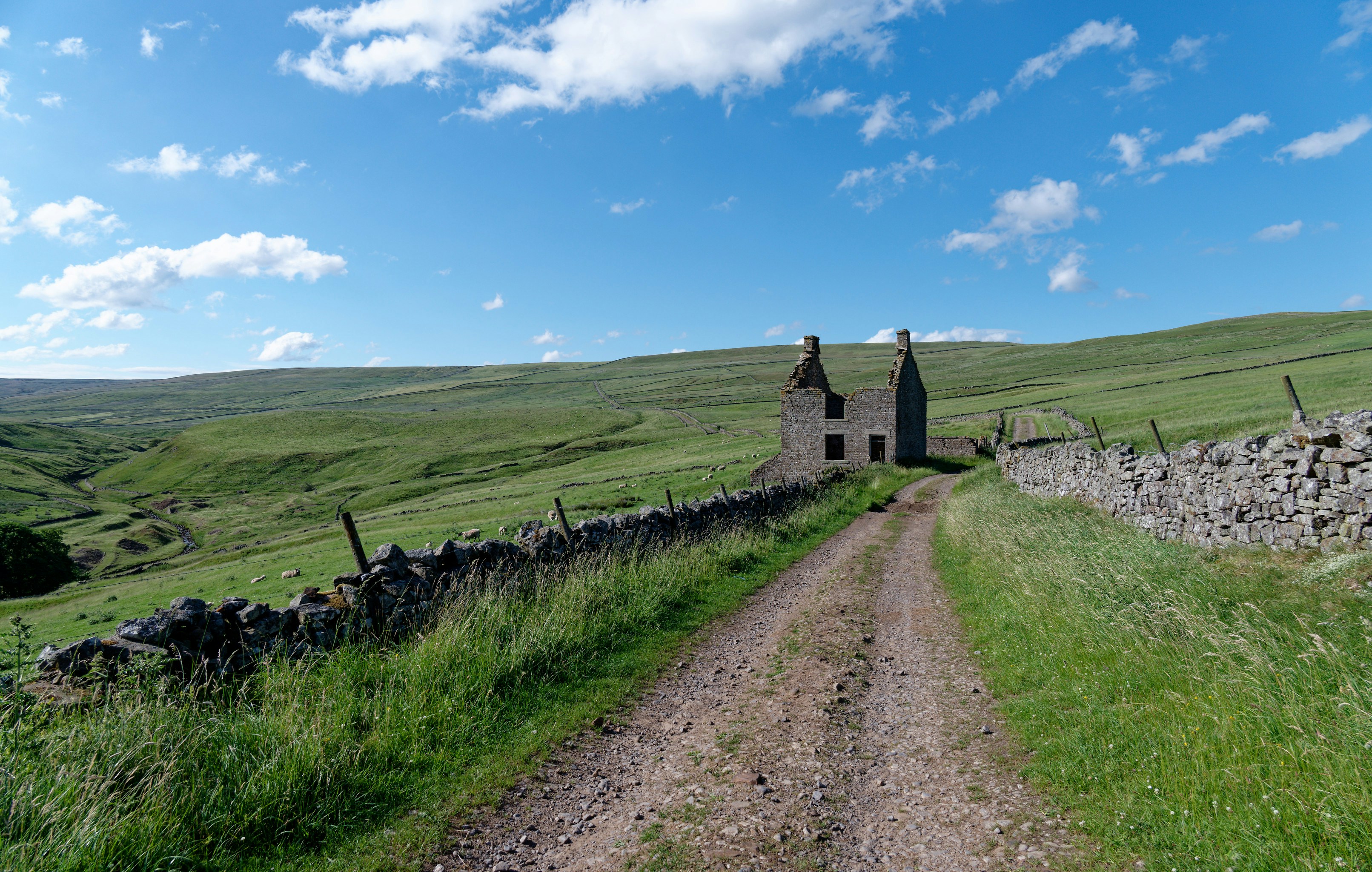 A Narrow Path to a Stone-Sheltered Chapel on a Rolling Moor
