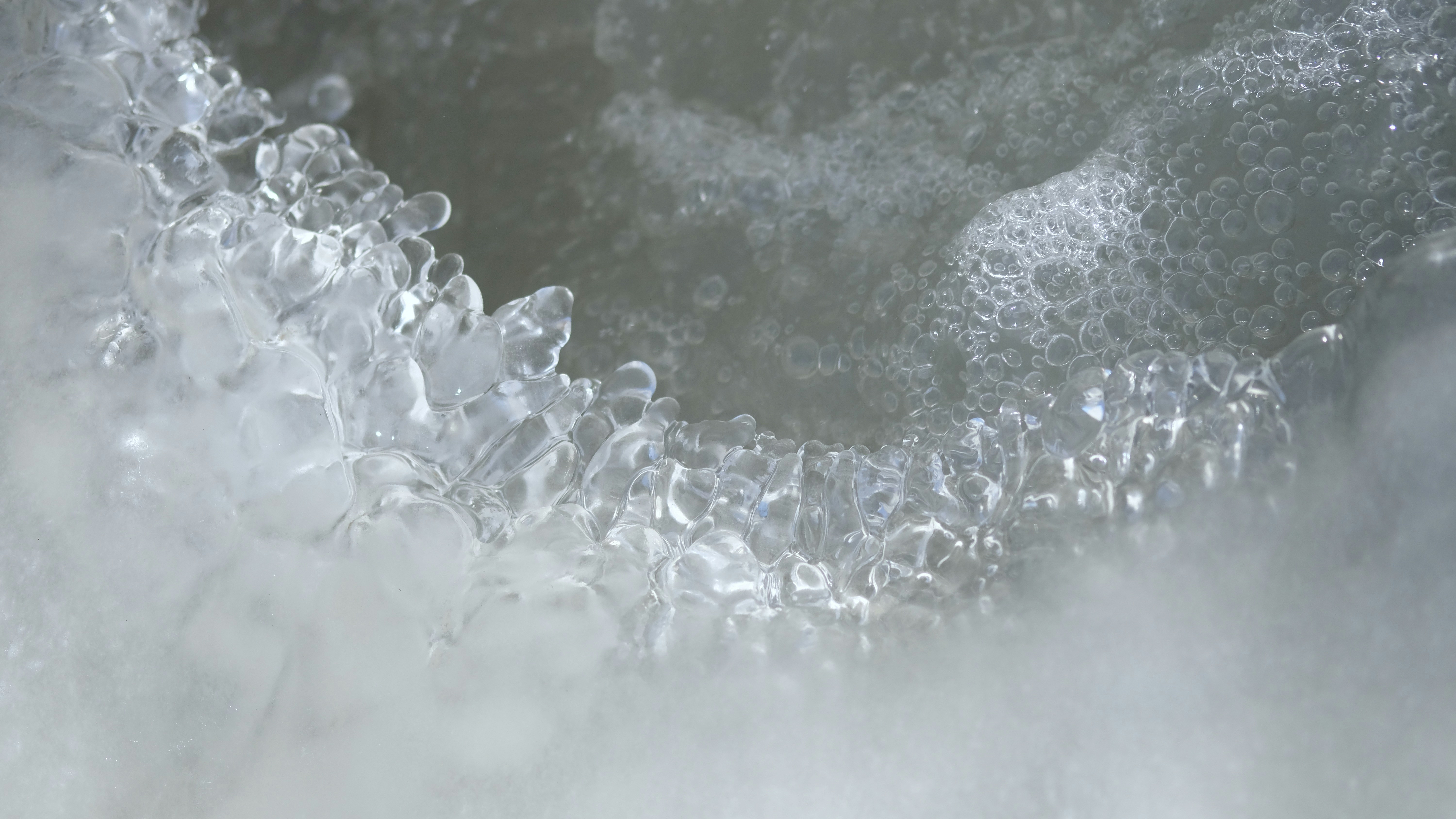 Frozen Bloom: Macro Capture of Icicle Edge and Foam