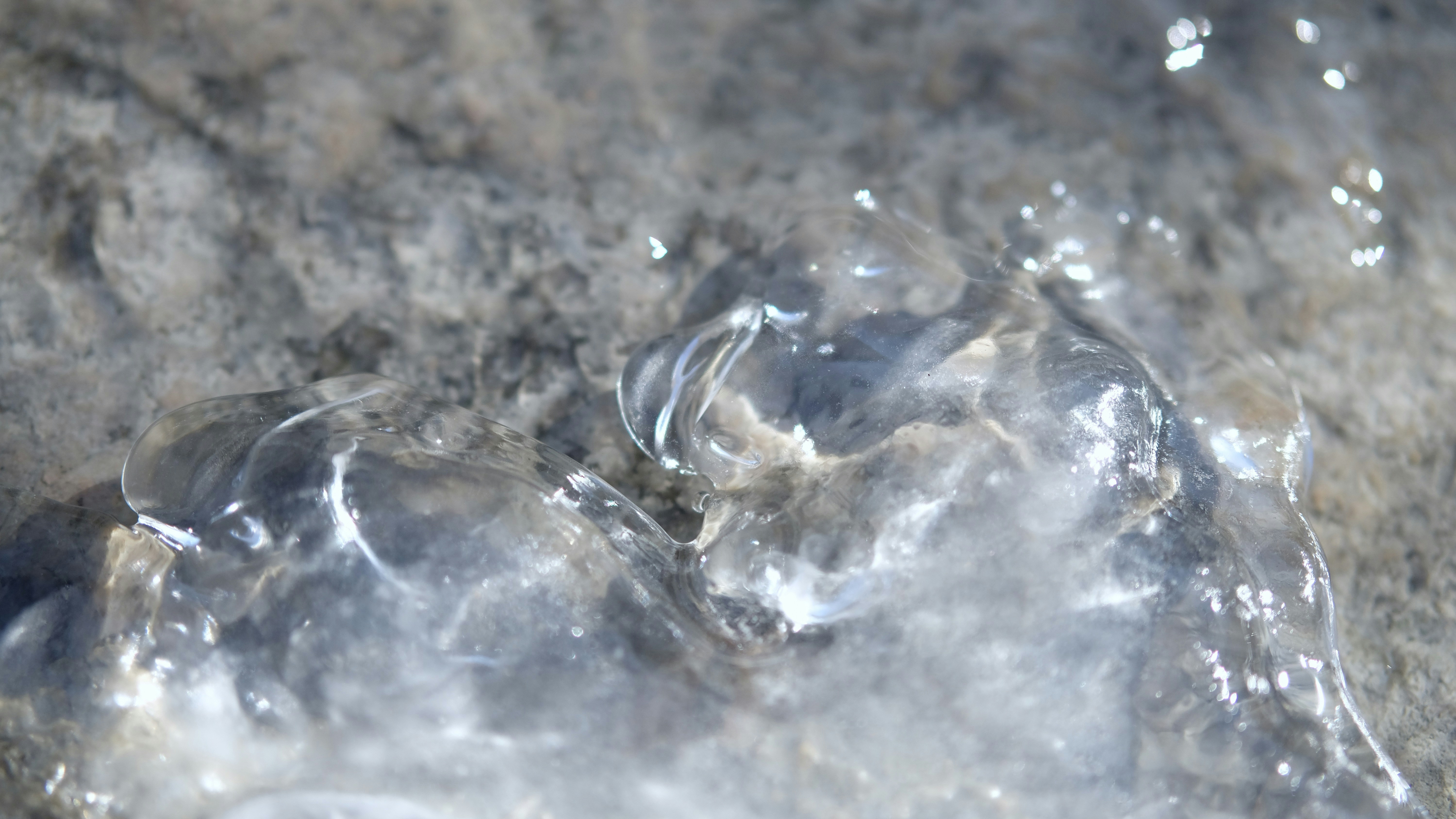 Ice-Cleaved Surface: A Glassy Crest on Wet Rock