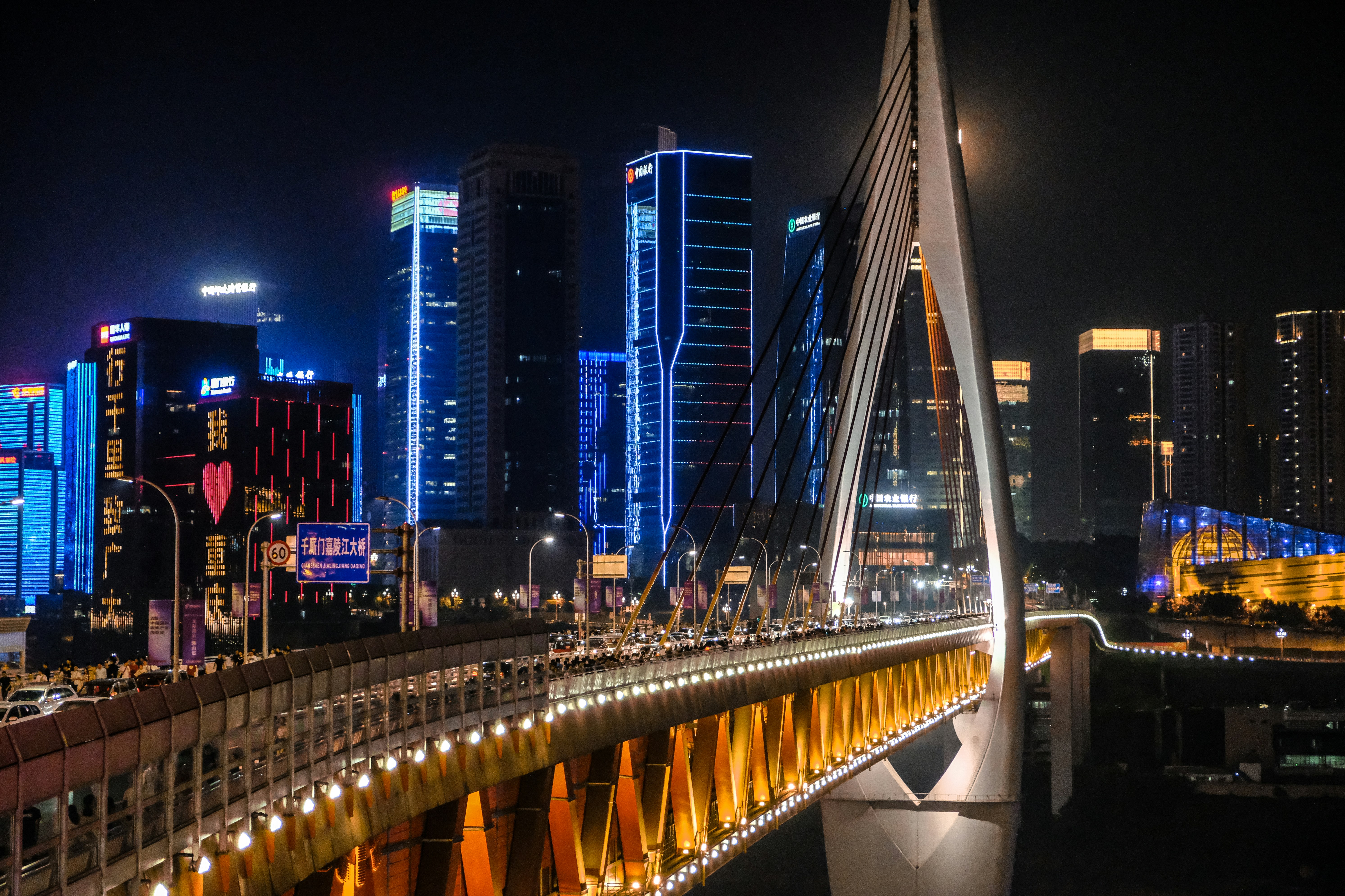 Neon Arc: Night-time Bridge Looms Over a Dreamlike City