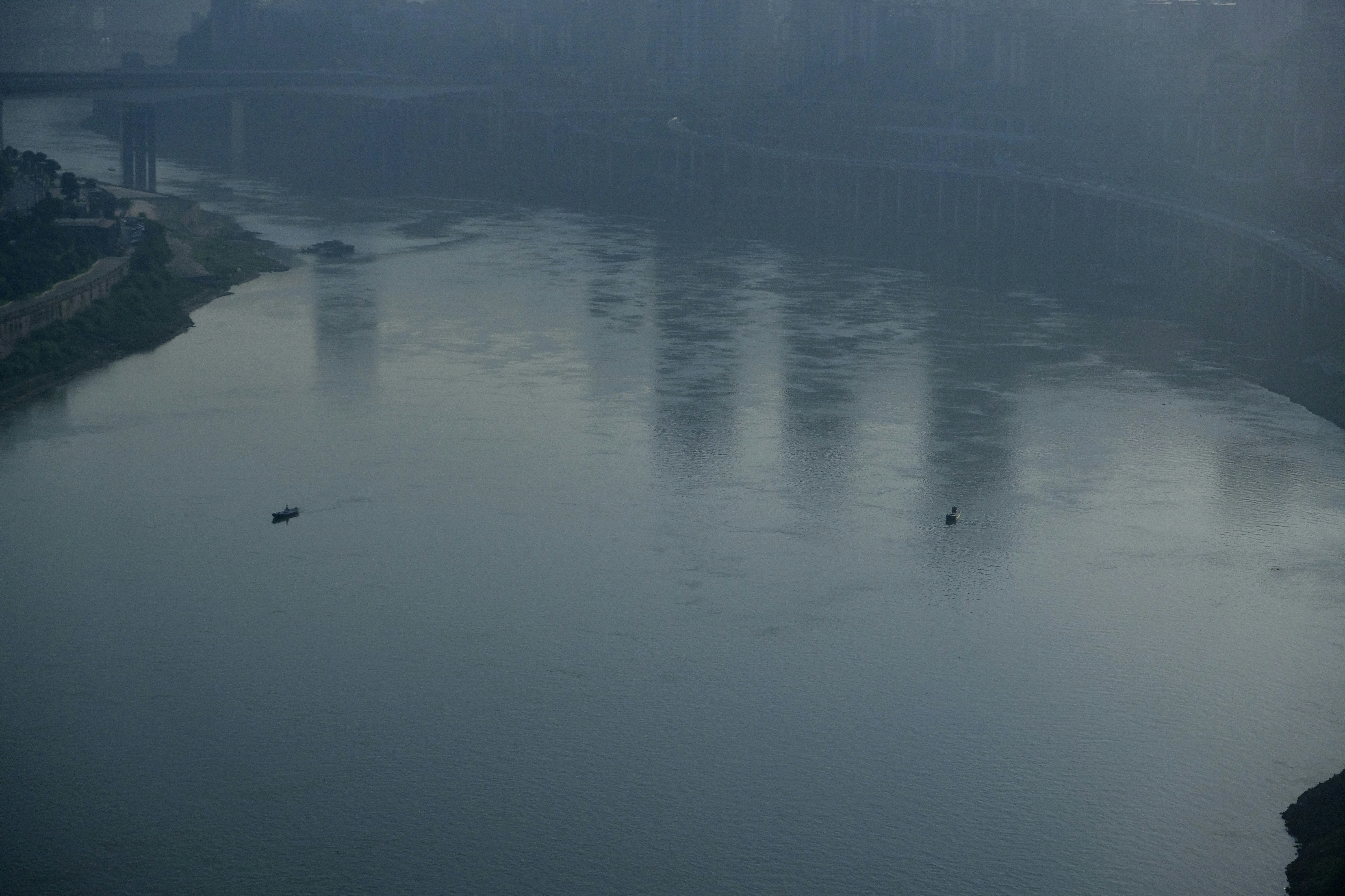 Misty River Quiet: Boats on a Distant Wake