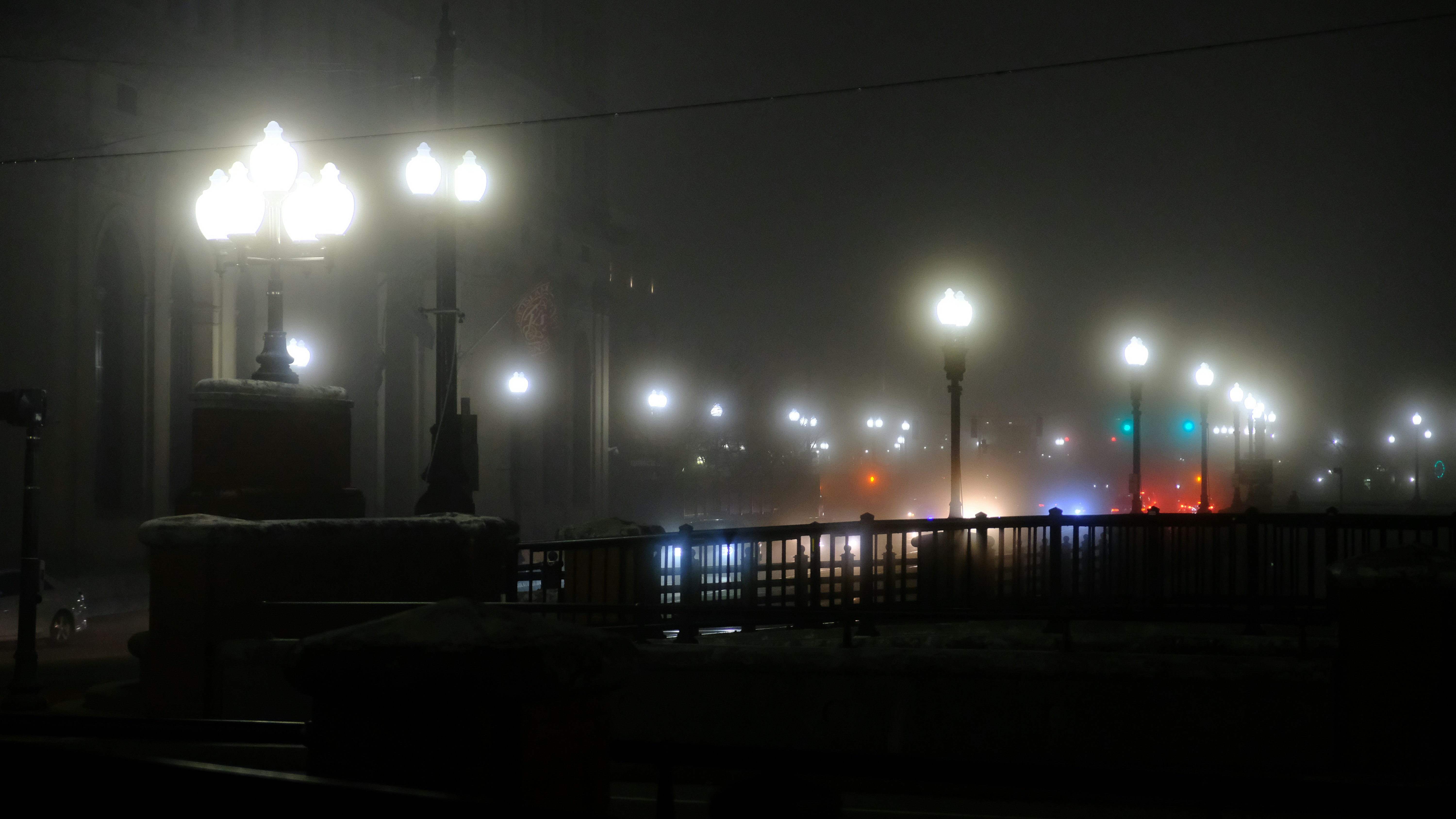 Foggy Riverside Lanterns: Quiet Nightfall Over a Dim Bridge