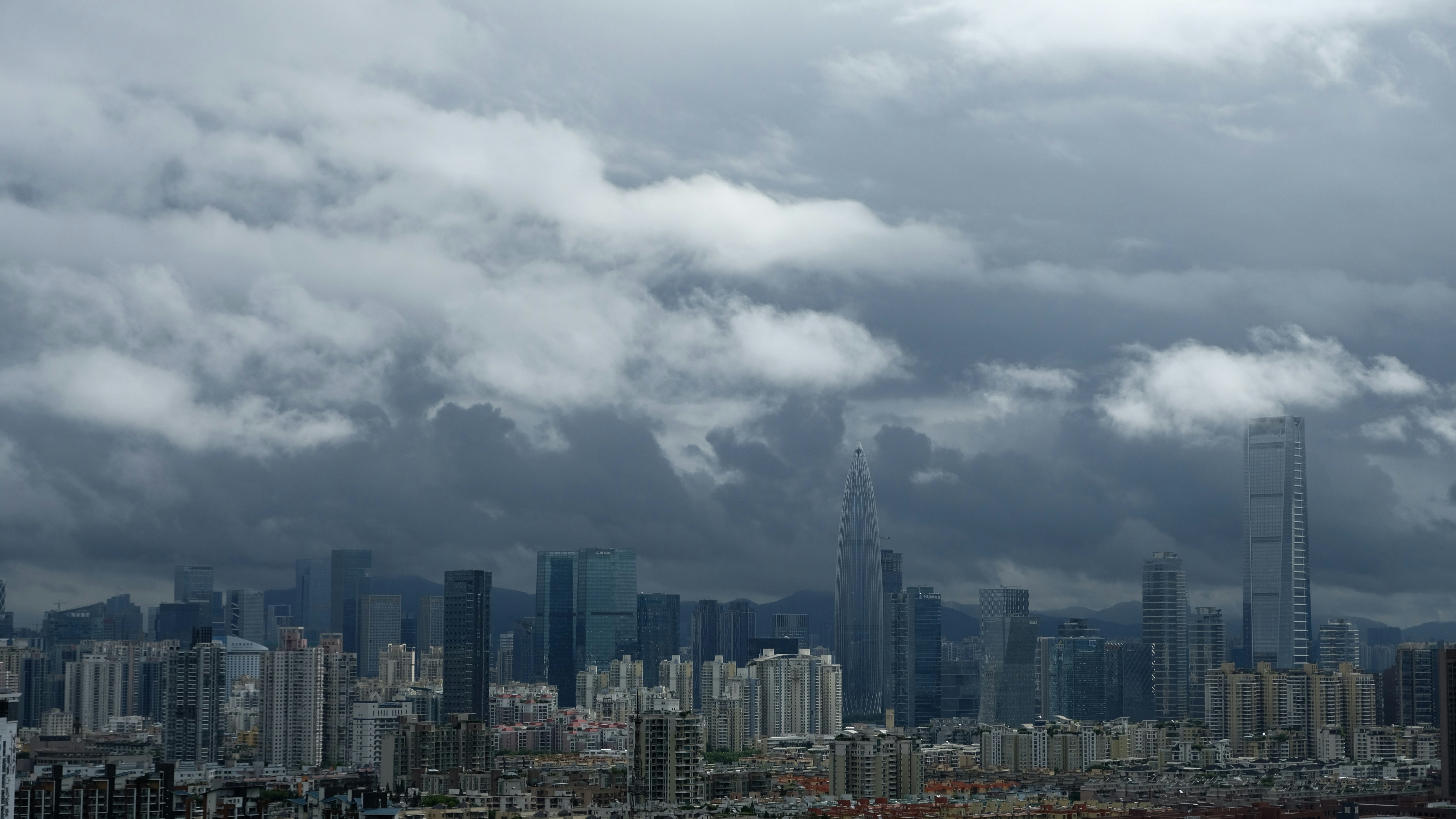 Cloud-Canked Skyline: A Distant City Under Pressed Skies