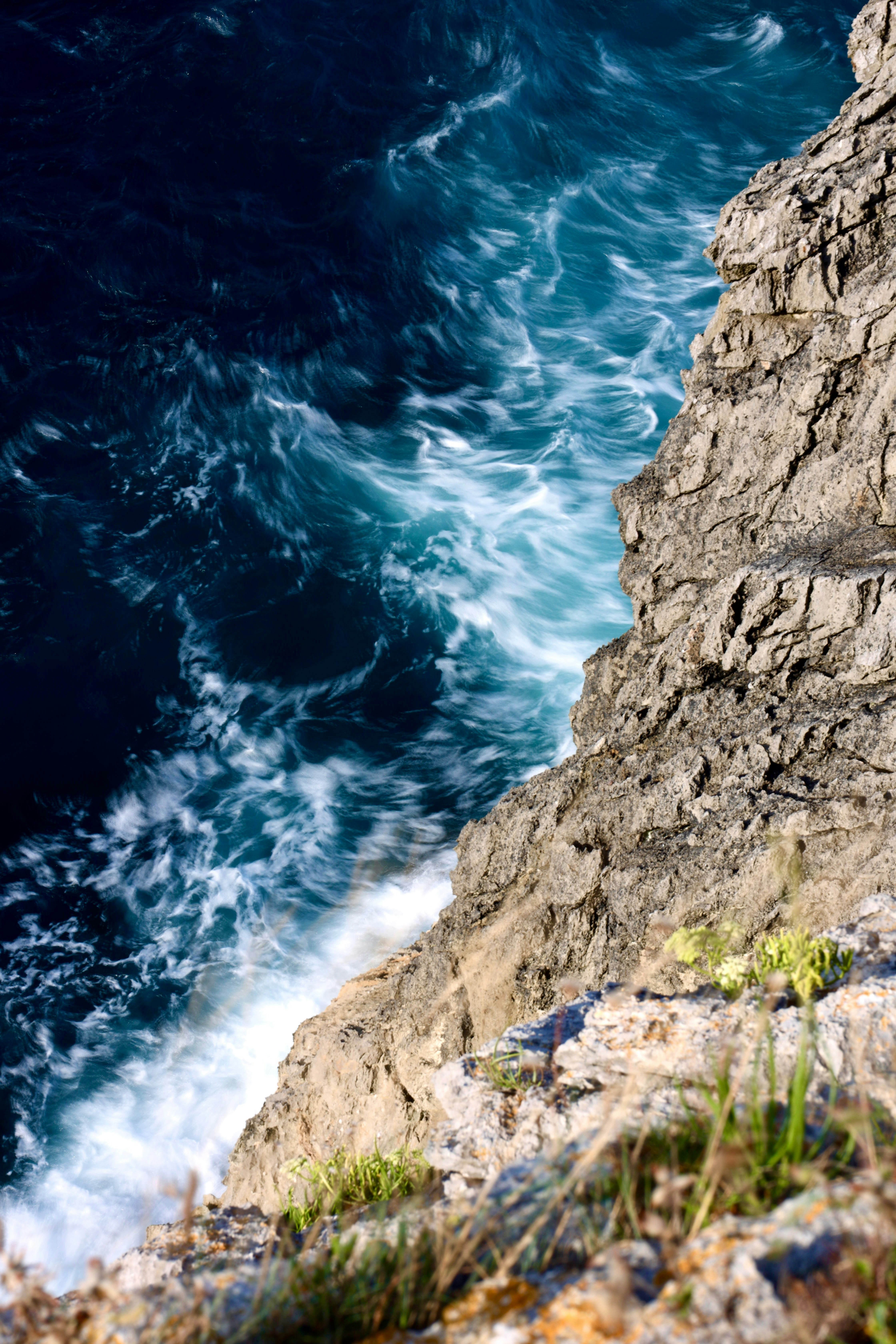 Cliffside Overlook: Perched Edge Above Turbulent Blue