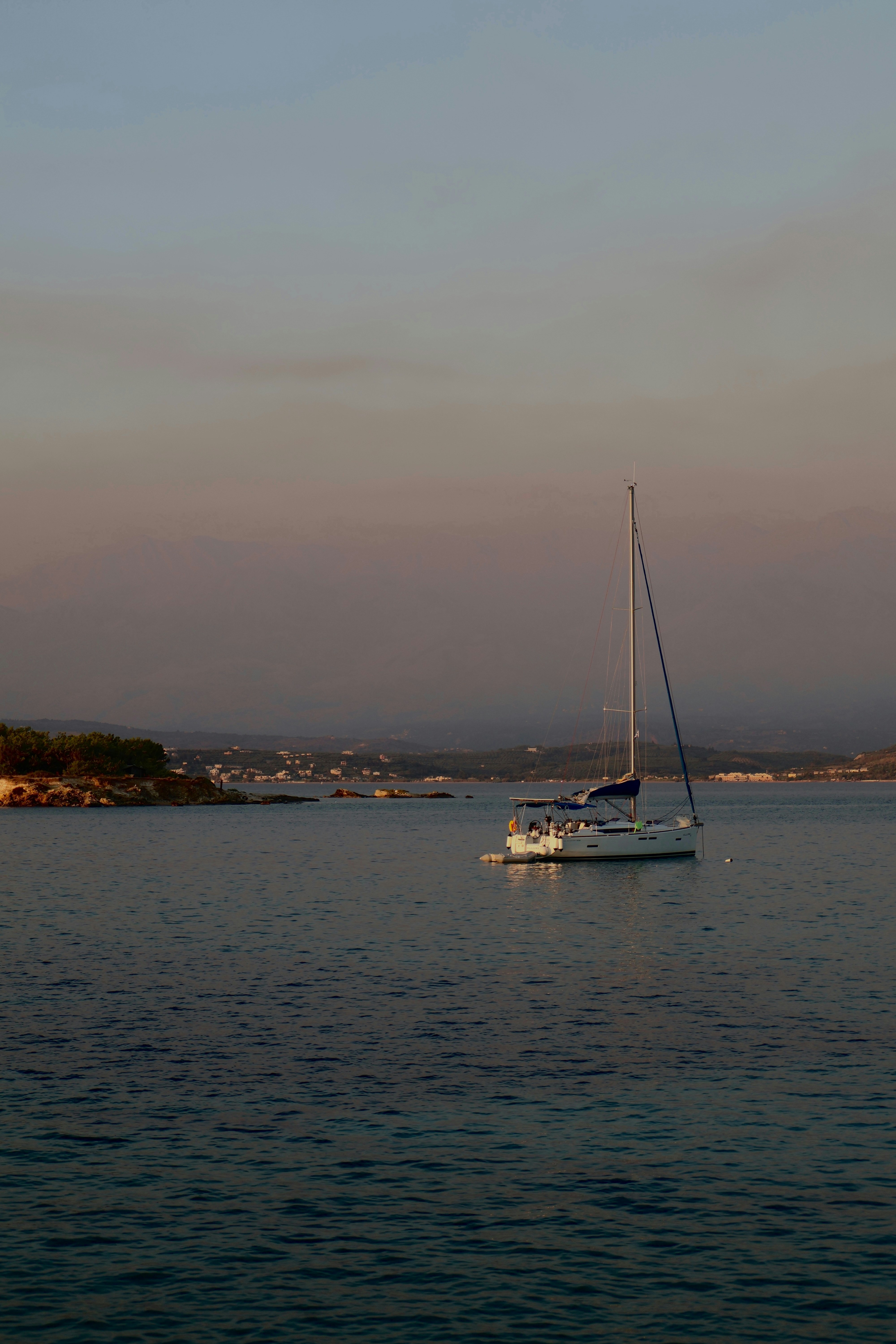 Sailboat in tranquil evening harbor