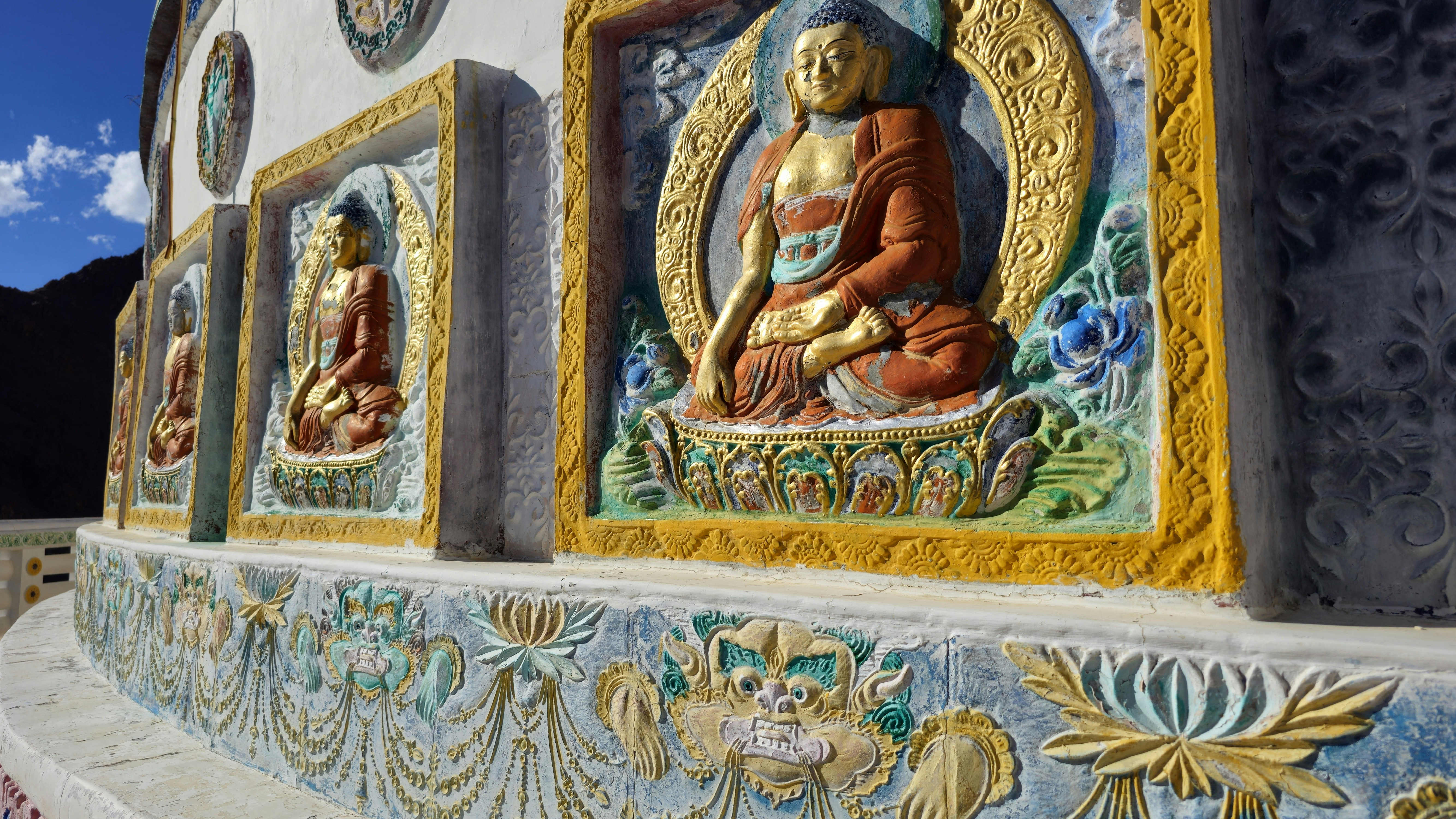 Carved Buddhas on a Colorful Monastic Wall