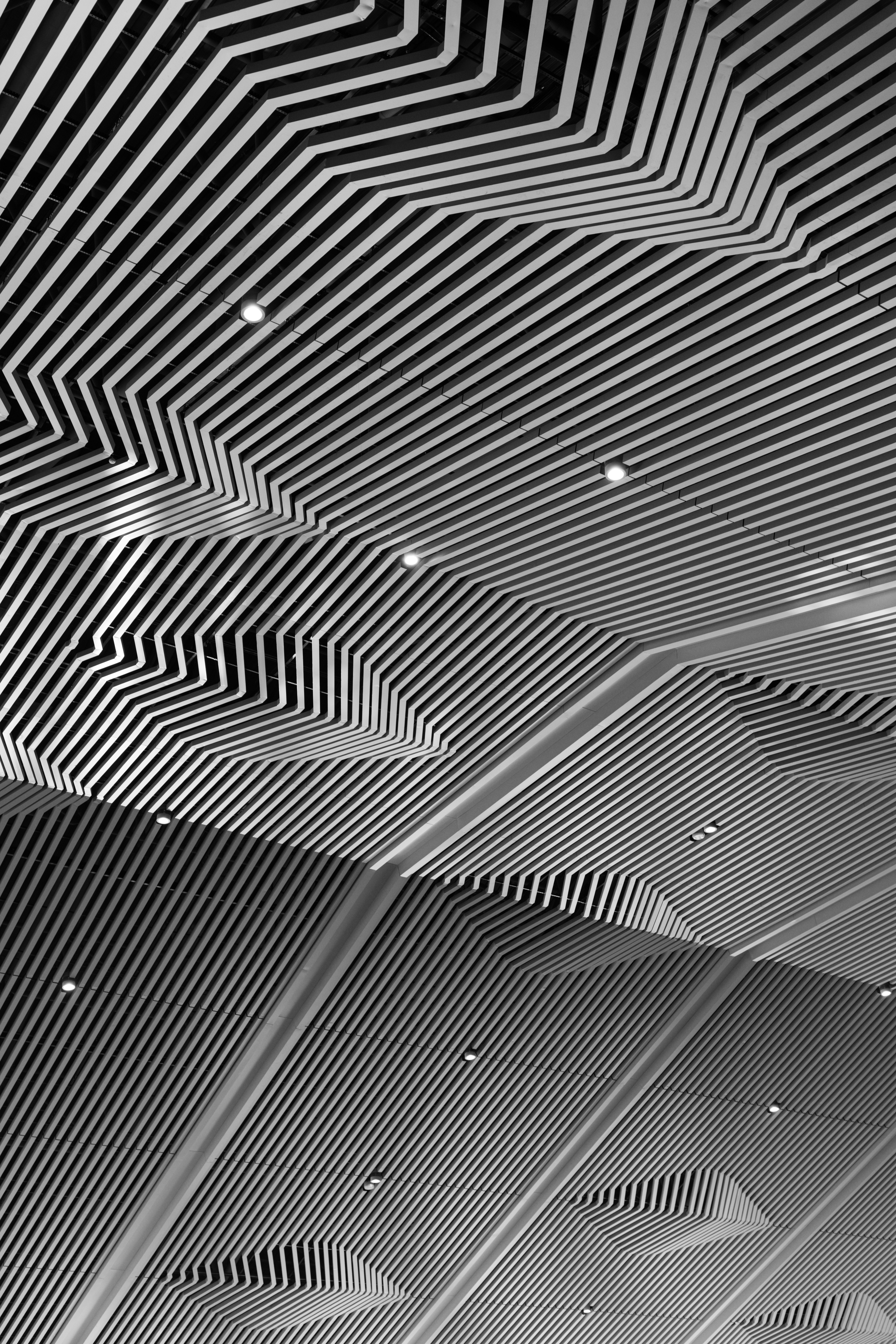 Warped Lines: An Architectural Illusion in a Grayscale Corridor