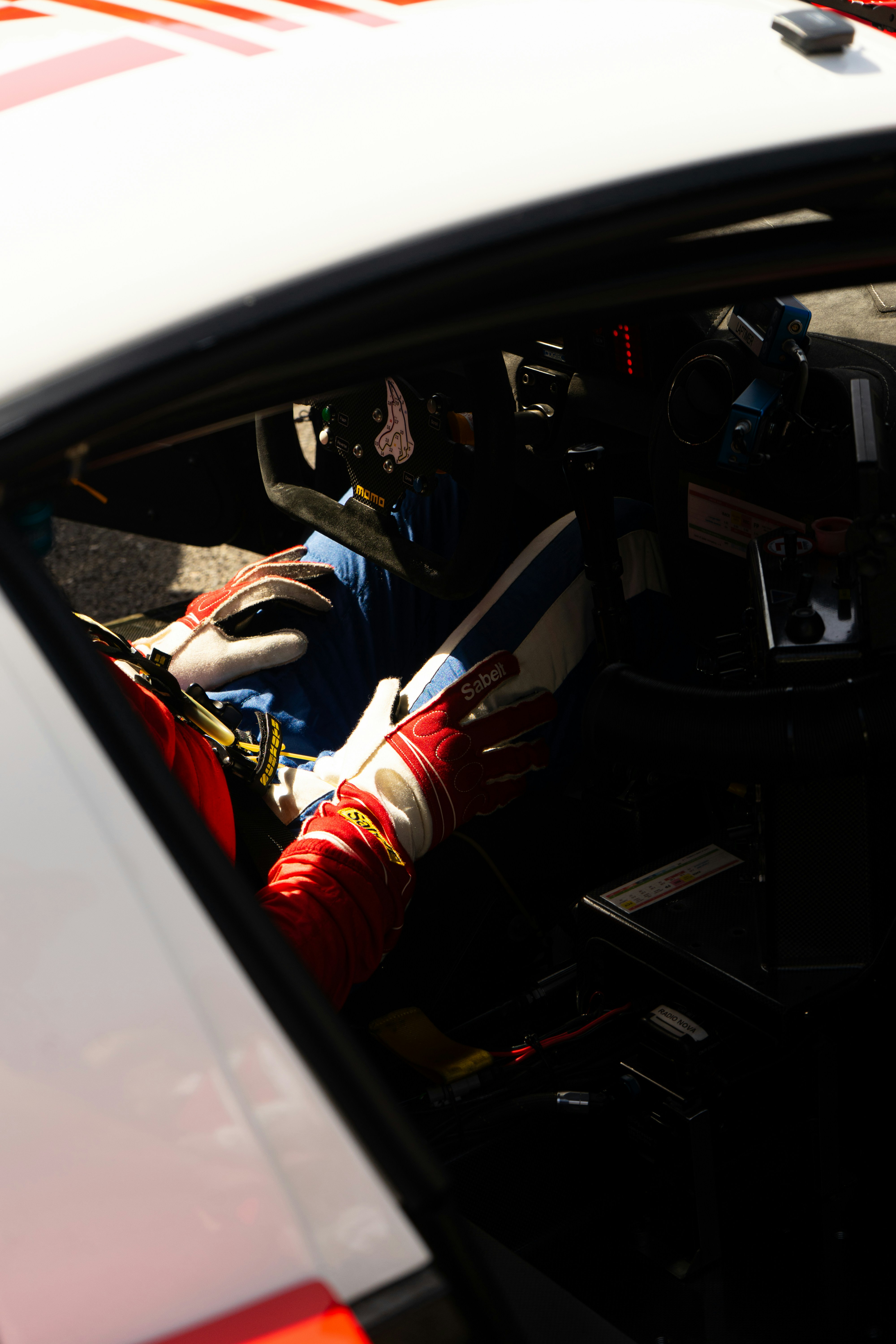 Hands at the Helm: Gloved Precision Inside a Racing Car cockpit