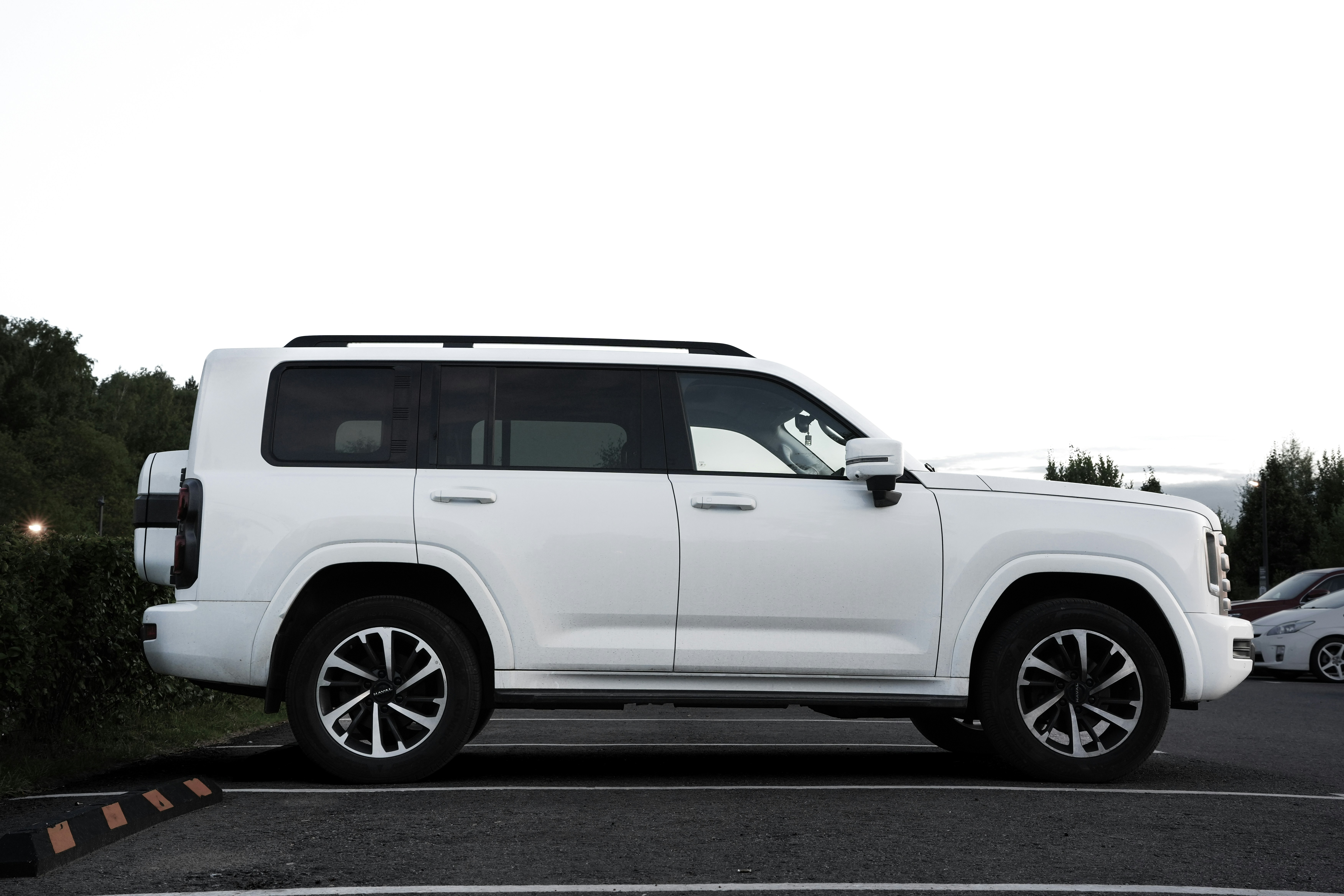 Side Profile of a White SUV in a Parking Lot