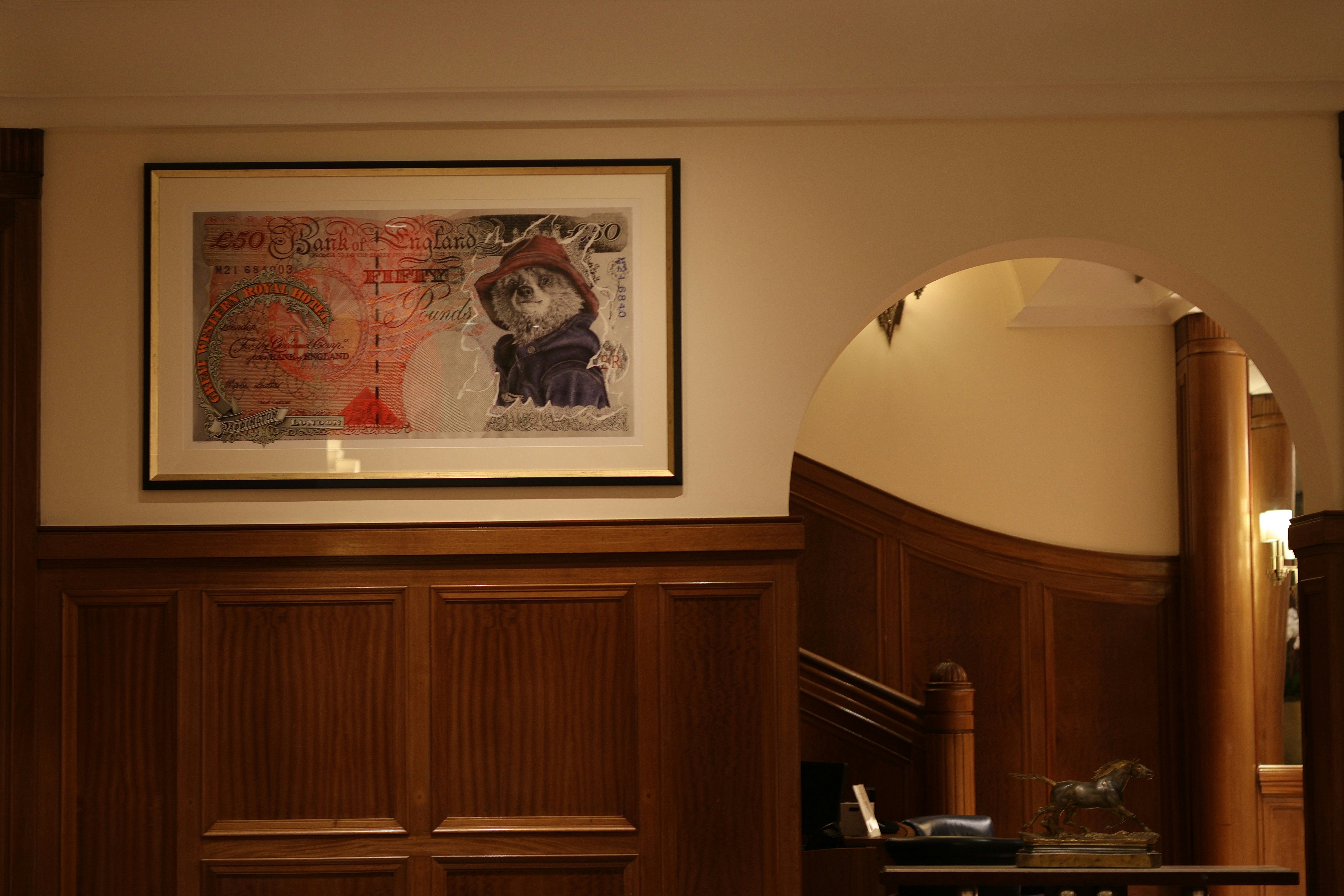 Framed Artwork Above Elegant Wood Paneling in Warm Interior