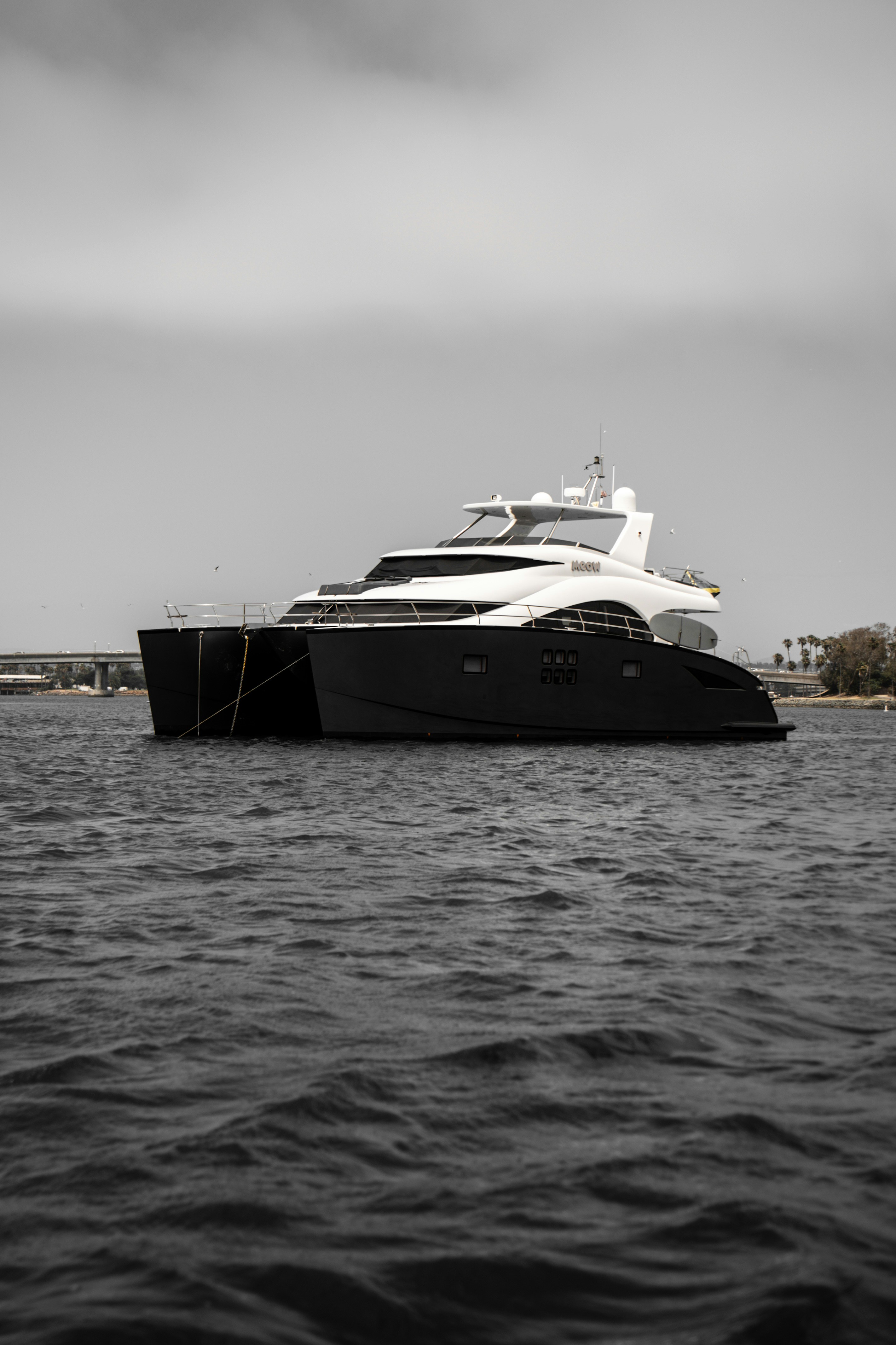 Luxurious Interlude: A Black-Towed Vessel Anchored under a Quiet Sky