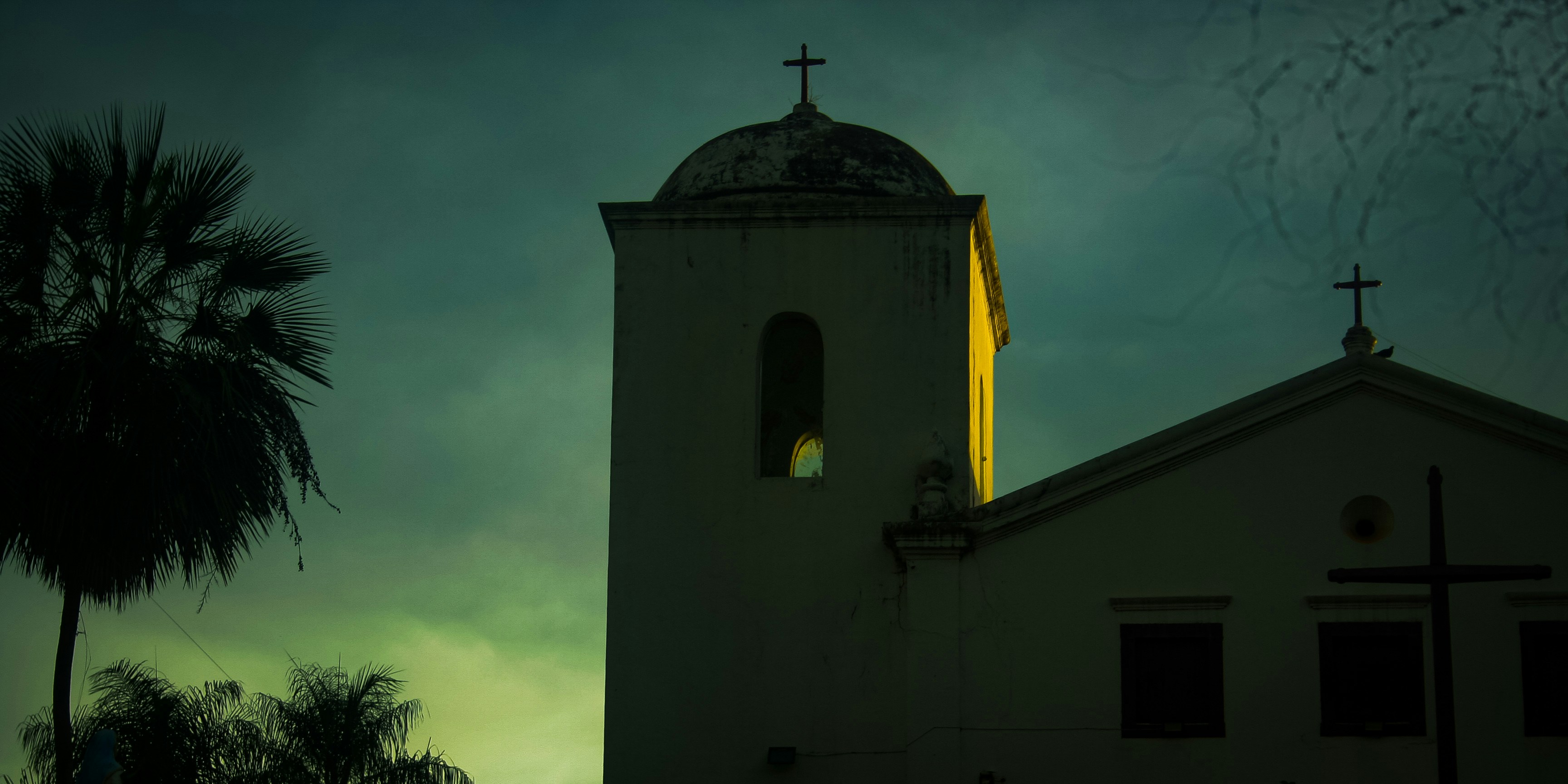 Sunlit Bell Tower at Dusk: A Quiet Chapel Under Evening Sky