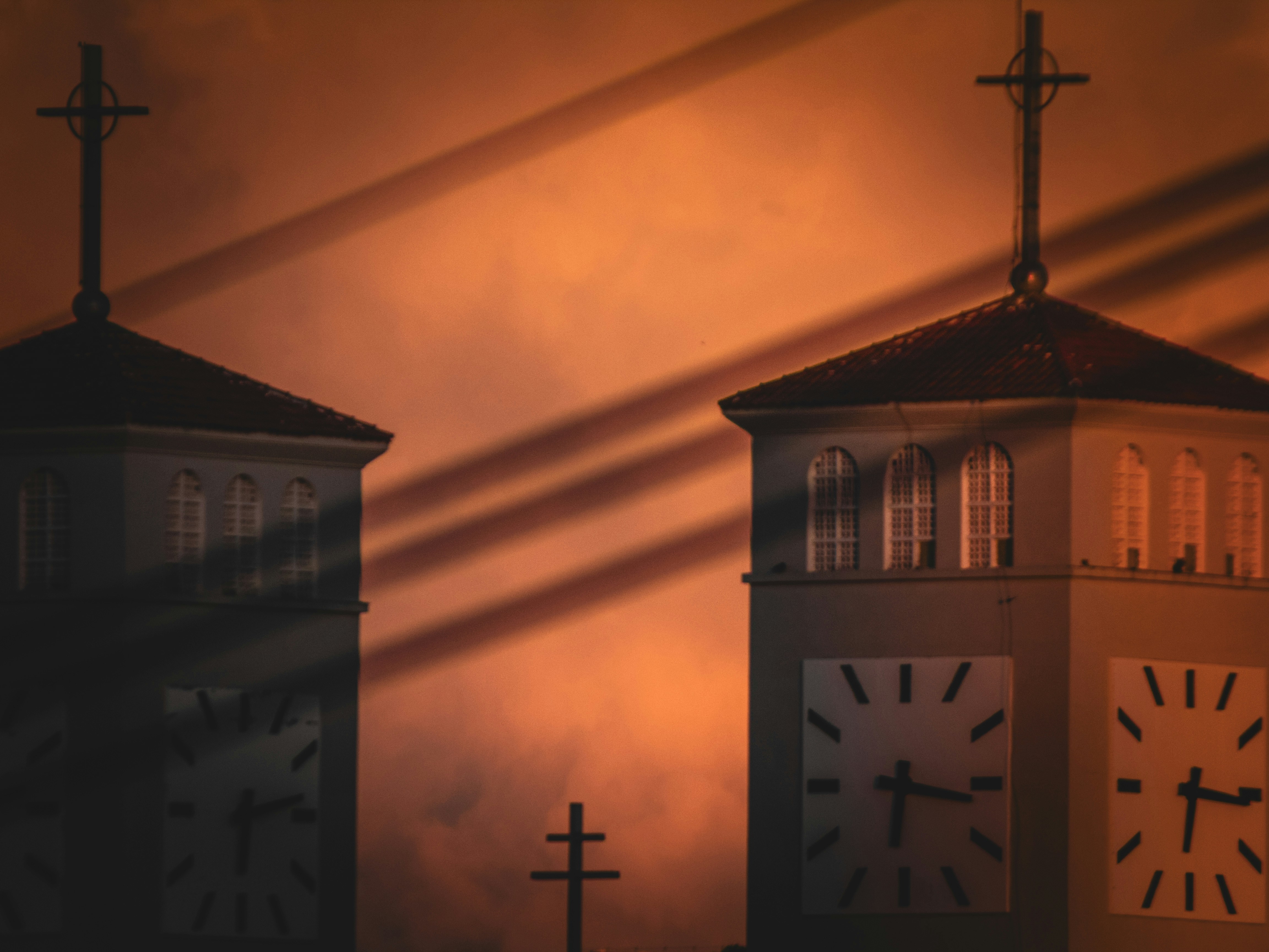 Twin Clock Towers Under Striated Sunset