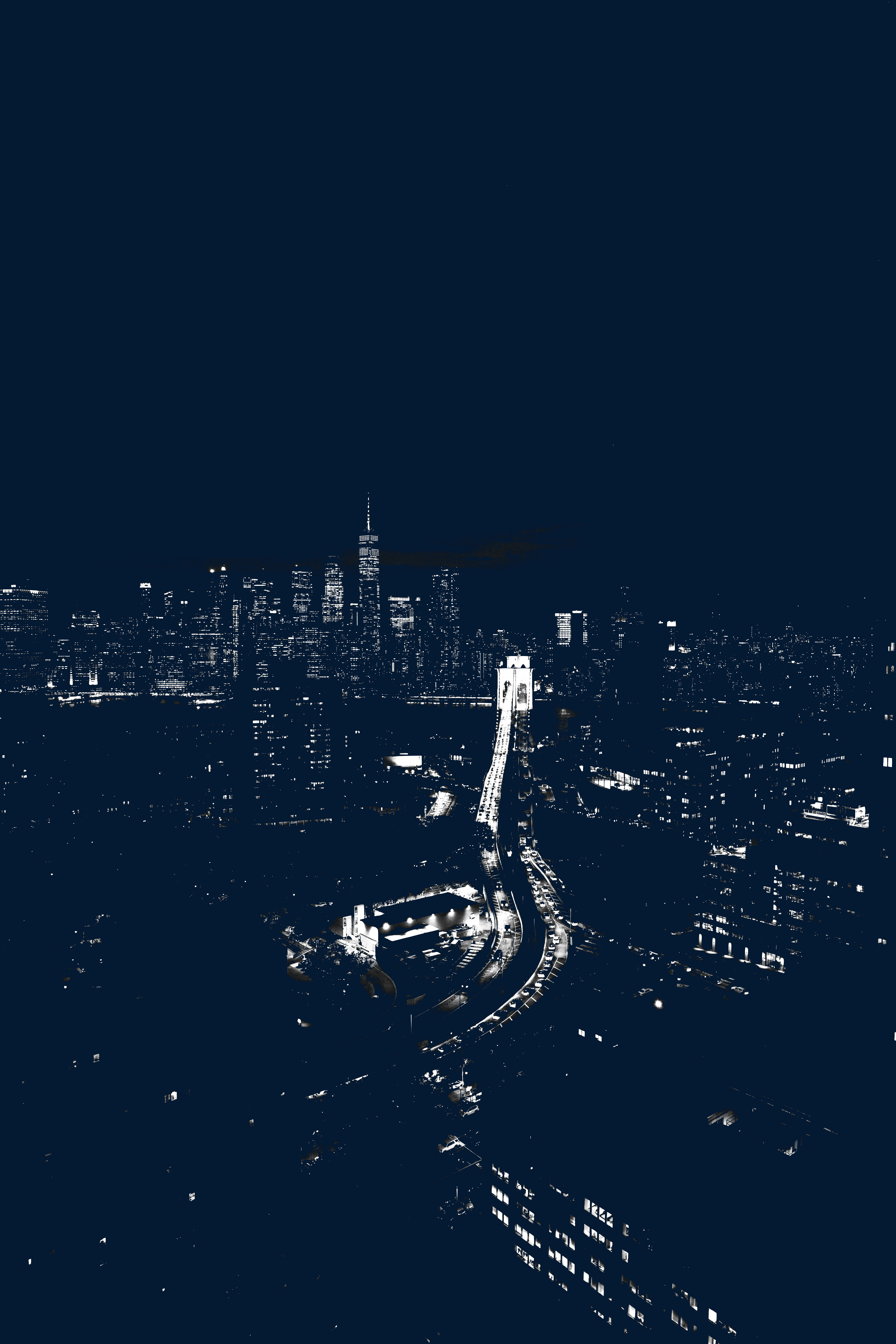 Dark blue night skyline with illuminated city buildings and a curved bridge, creating a dramatic urban composition.