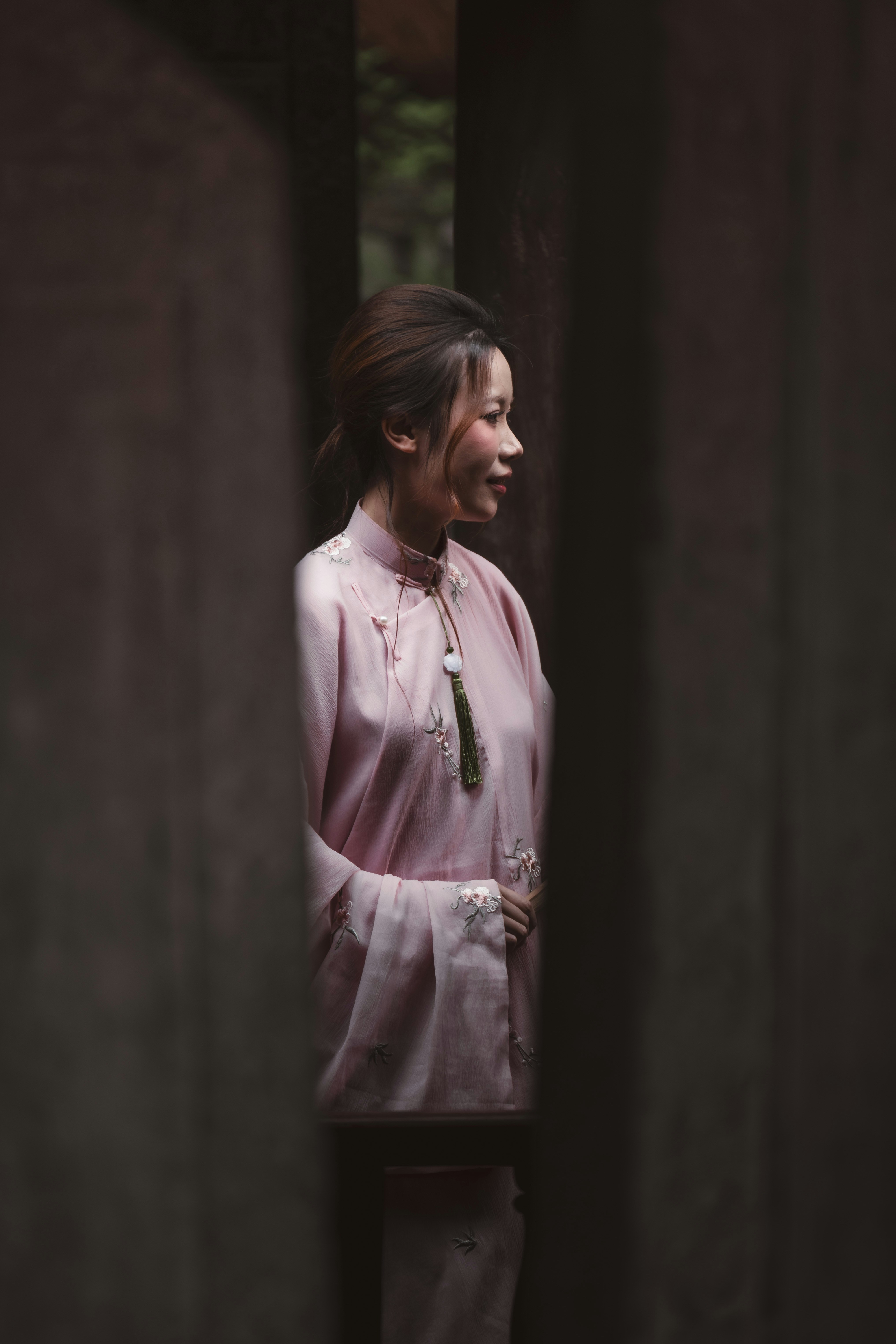 Portrait through Columns: A Quiet Moment in Pink