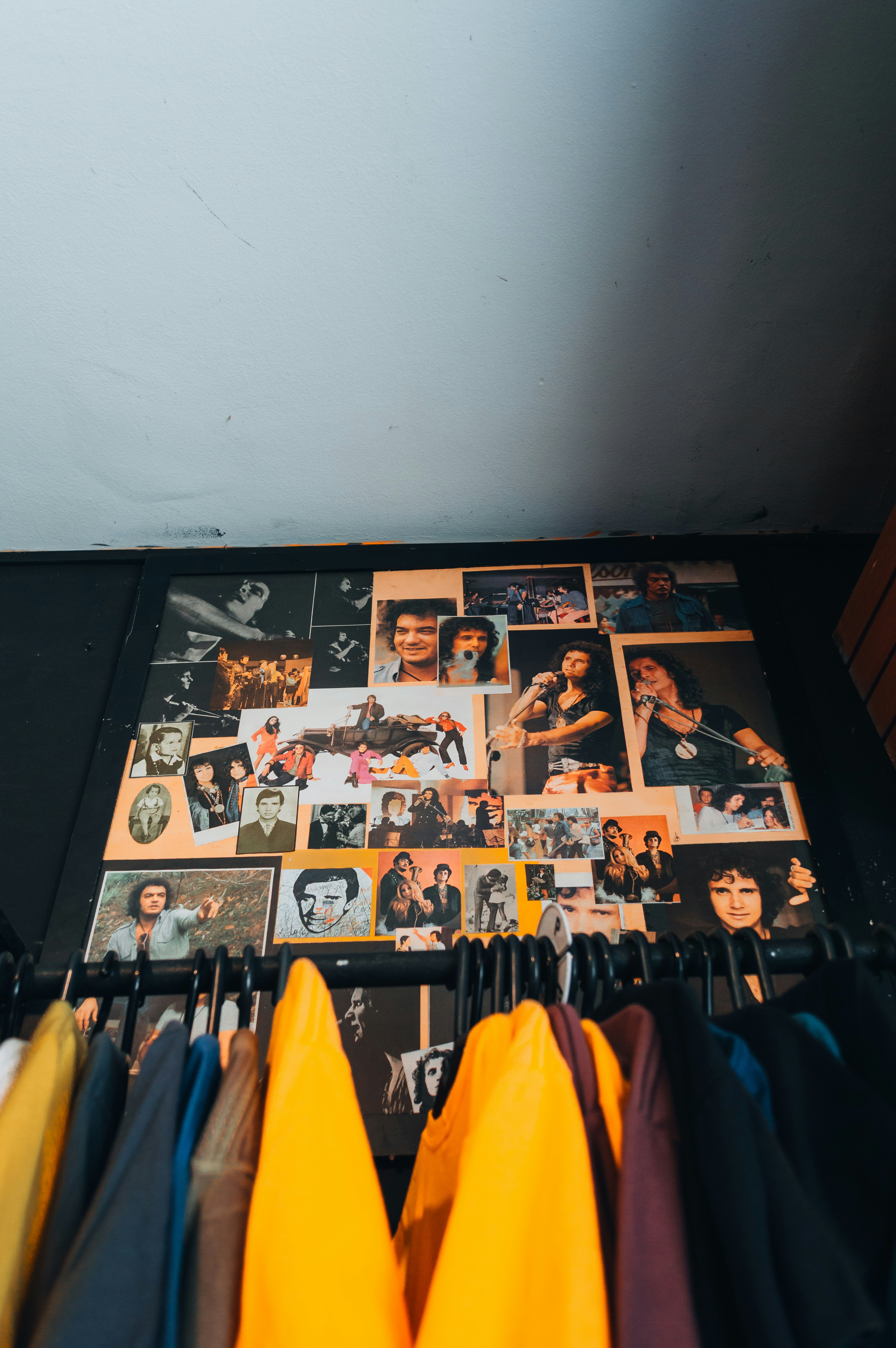 Wardrobe Collage: A Display of Colorful Attire Against a Wall of Memories