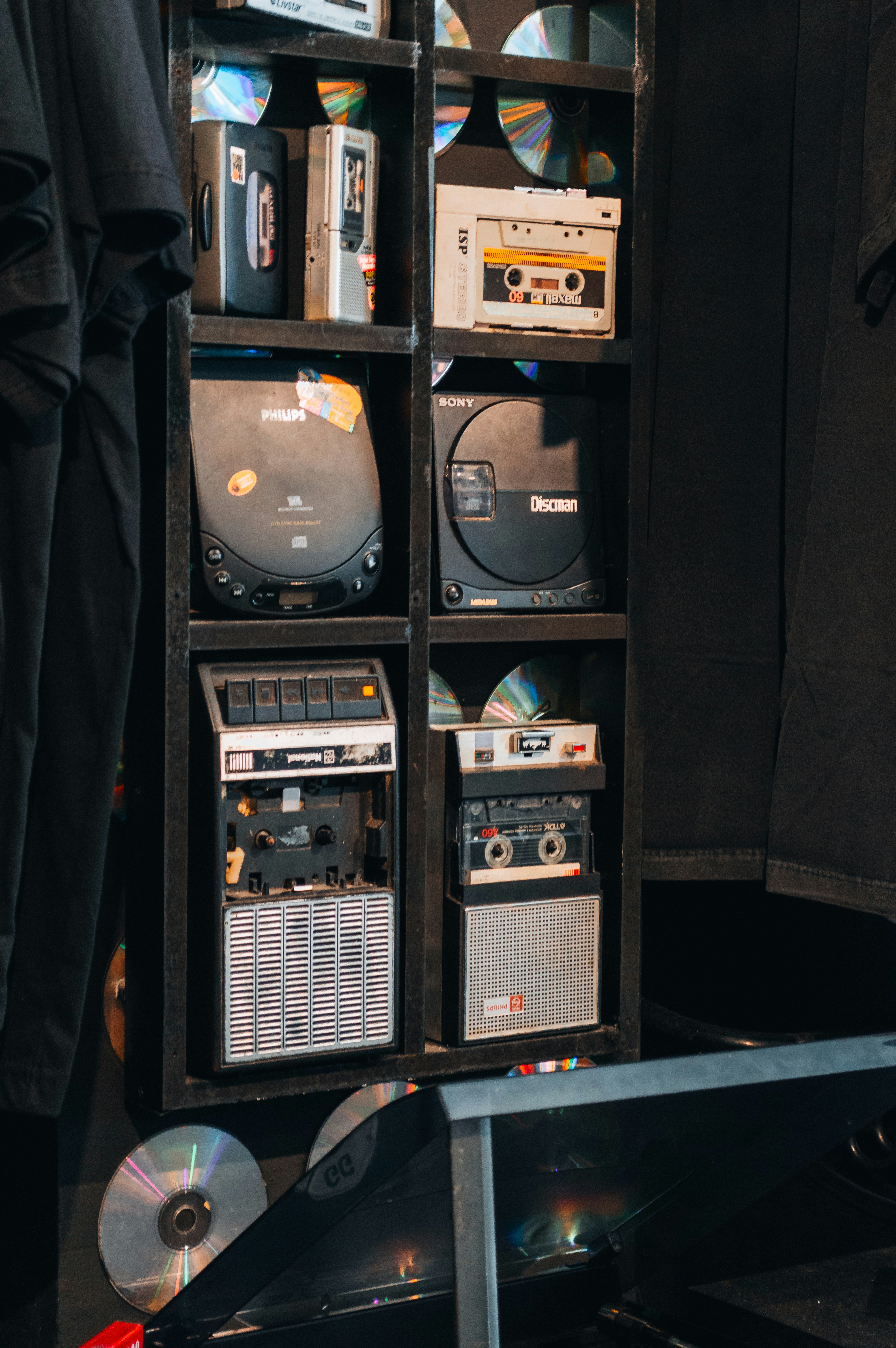 Shelf of vintage tapes and players: a closet of retro tech