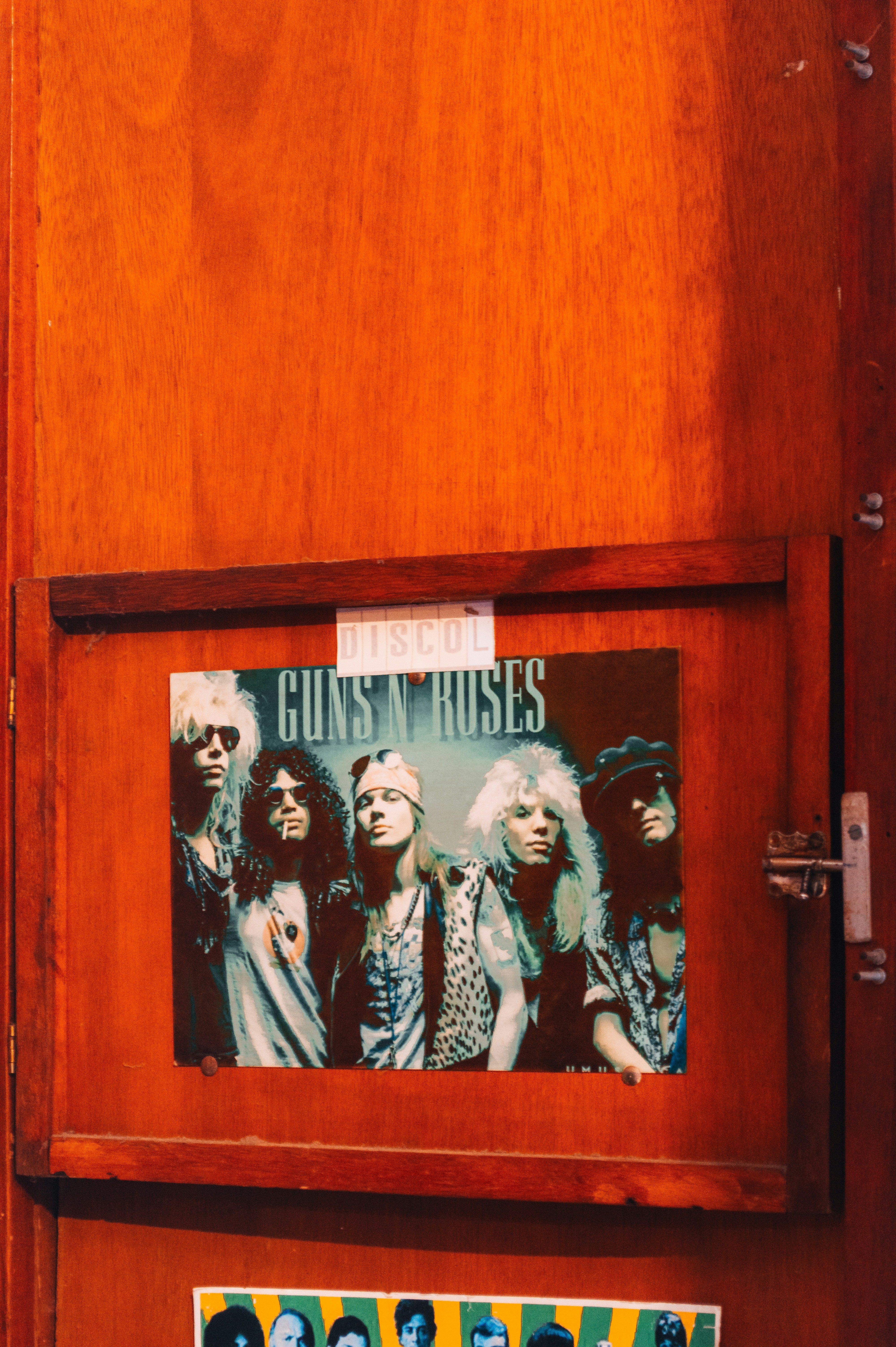 Guns N' Roses in Wood frame: vintage poster under warm amber glow