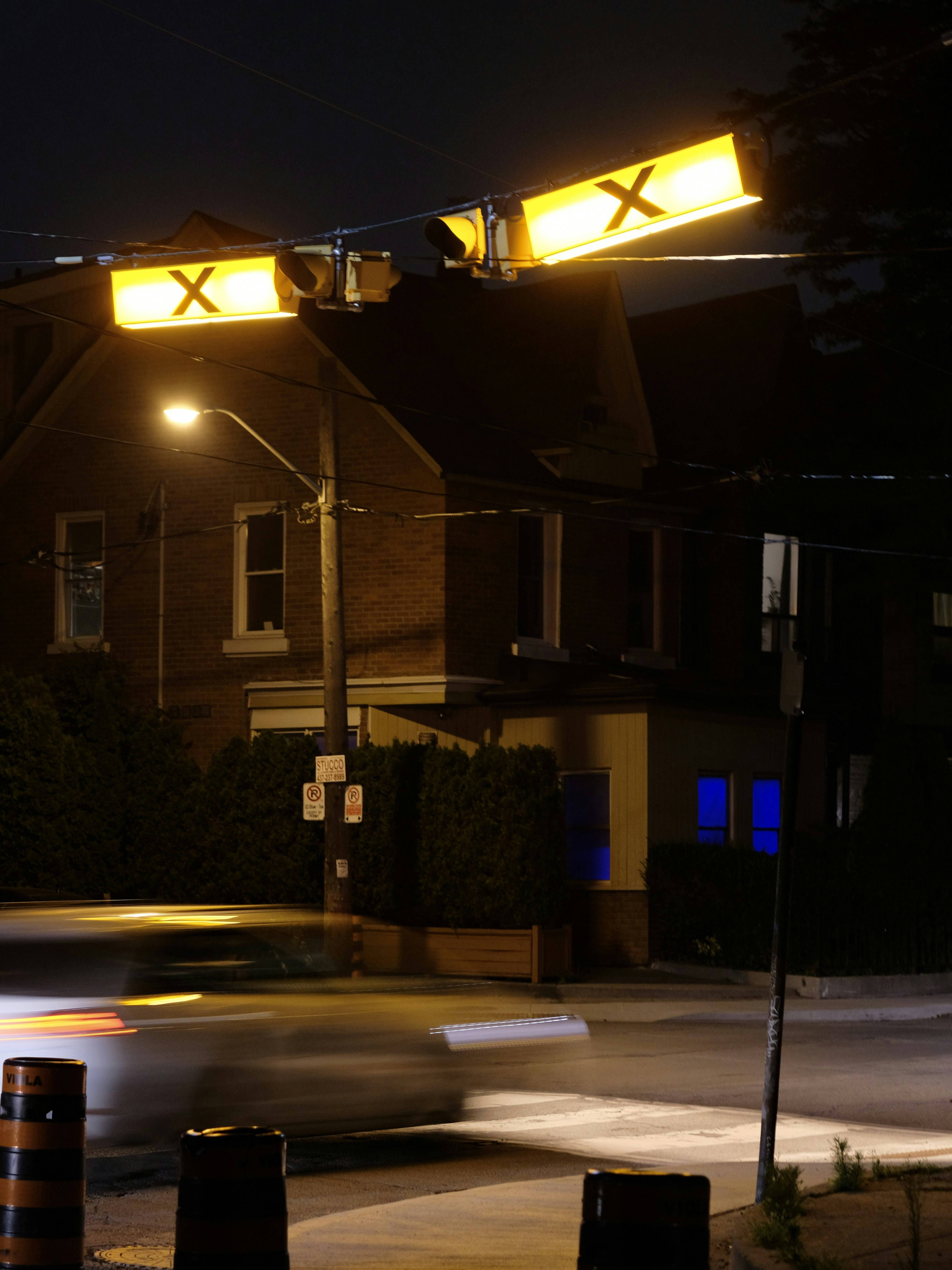 Crossing Signals at Night: A Quiet Street Under a Glowing X