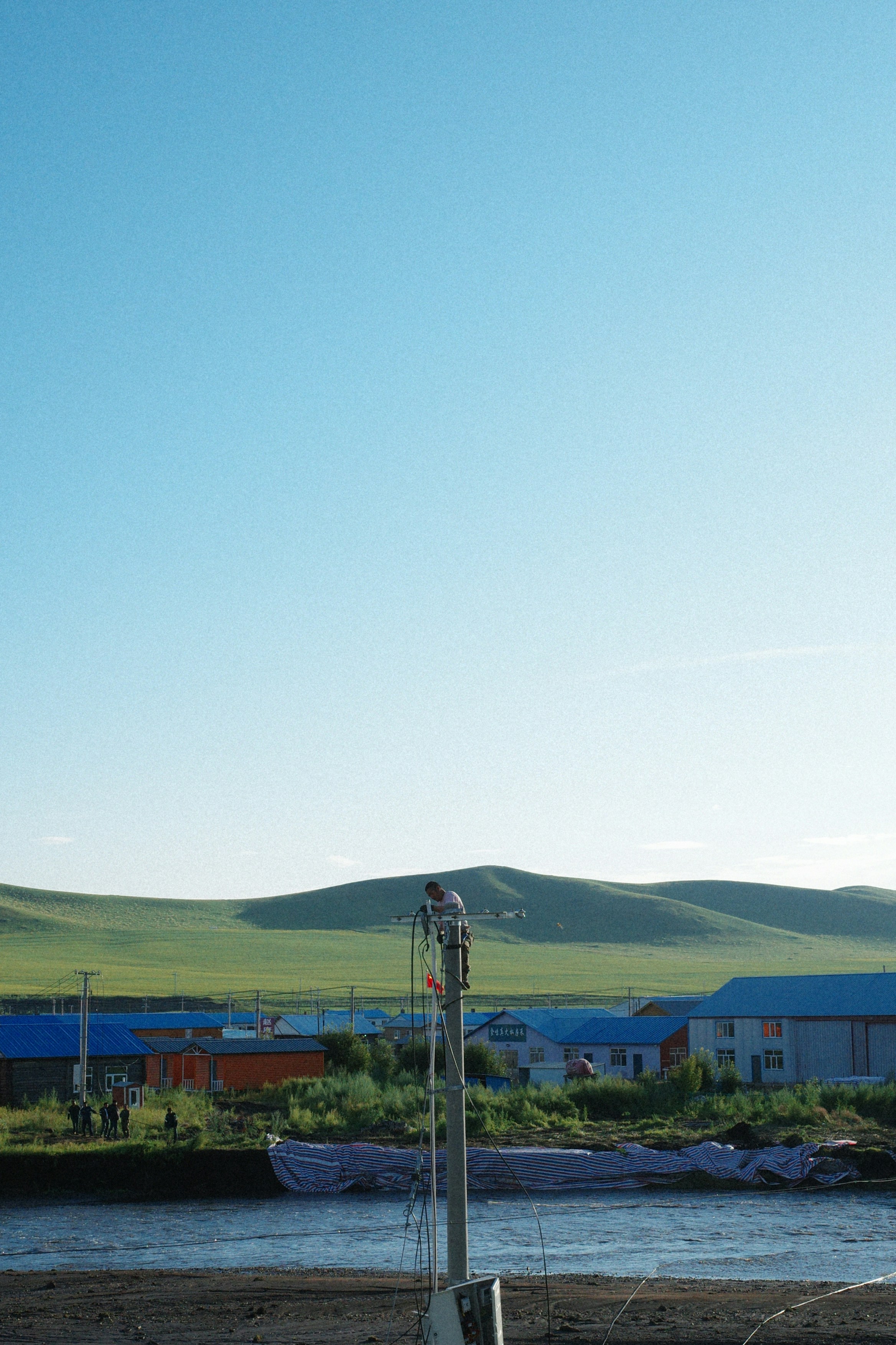 Lifeguard Tower Against Rolling Green Hills and River