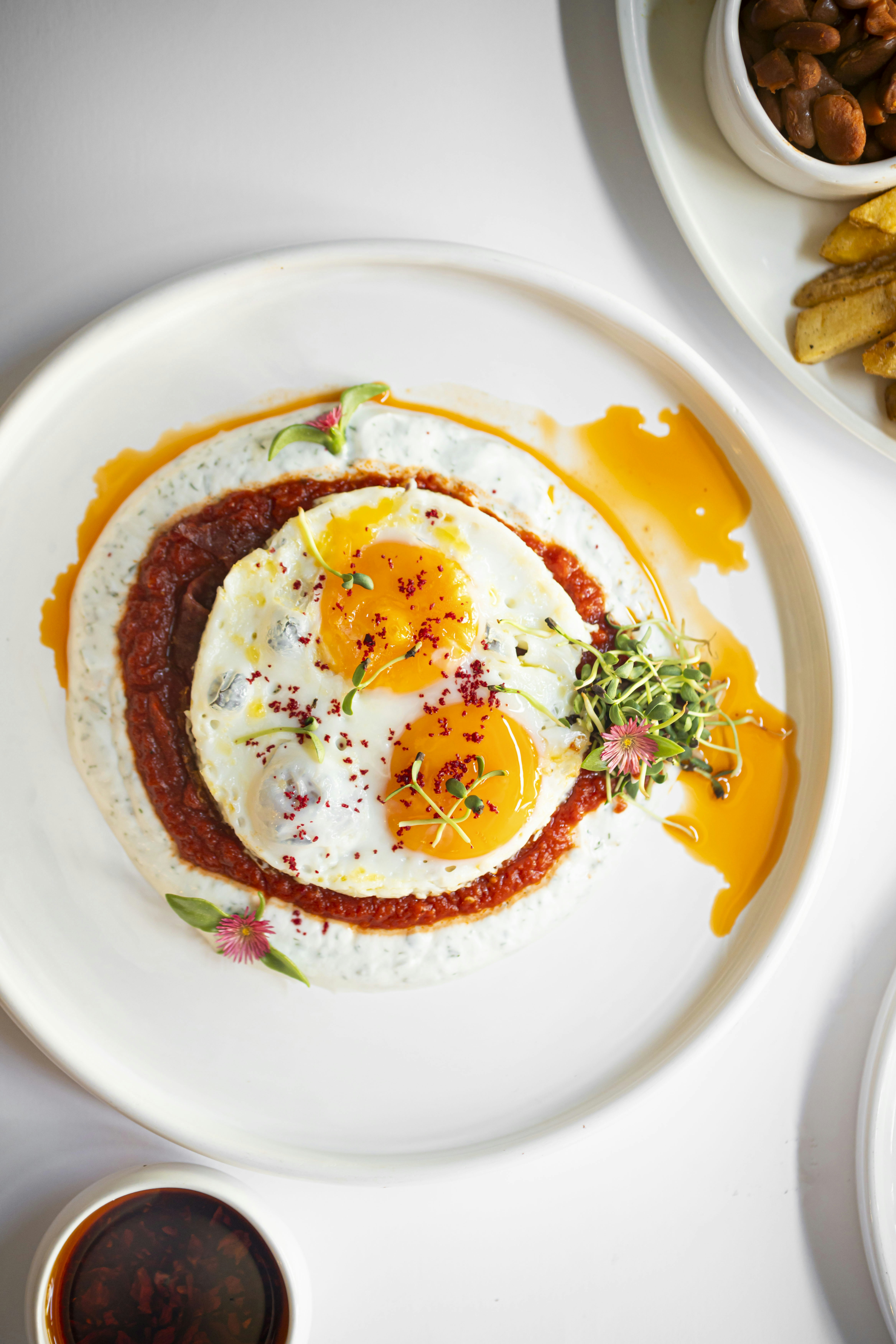 Sunny Eggs on Red Pepper Ring: A Morning Plate with Greens and Microgreens
