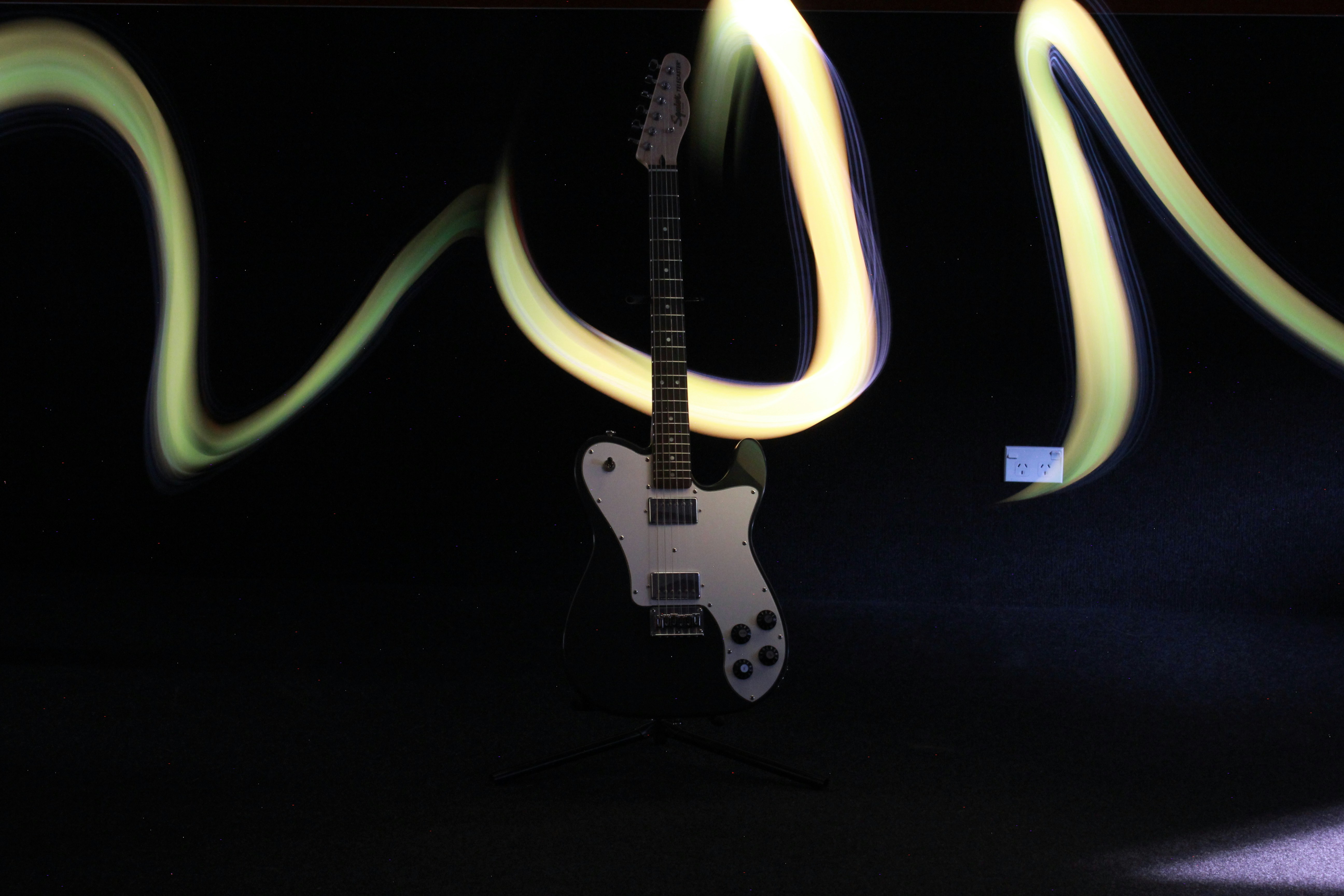Midnight riff: a lone guitar suspended in flowing light