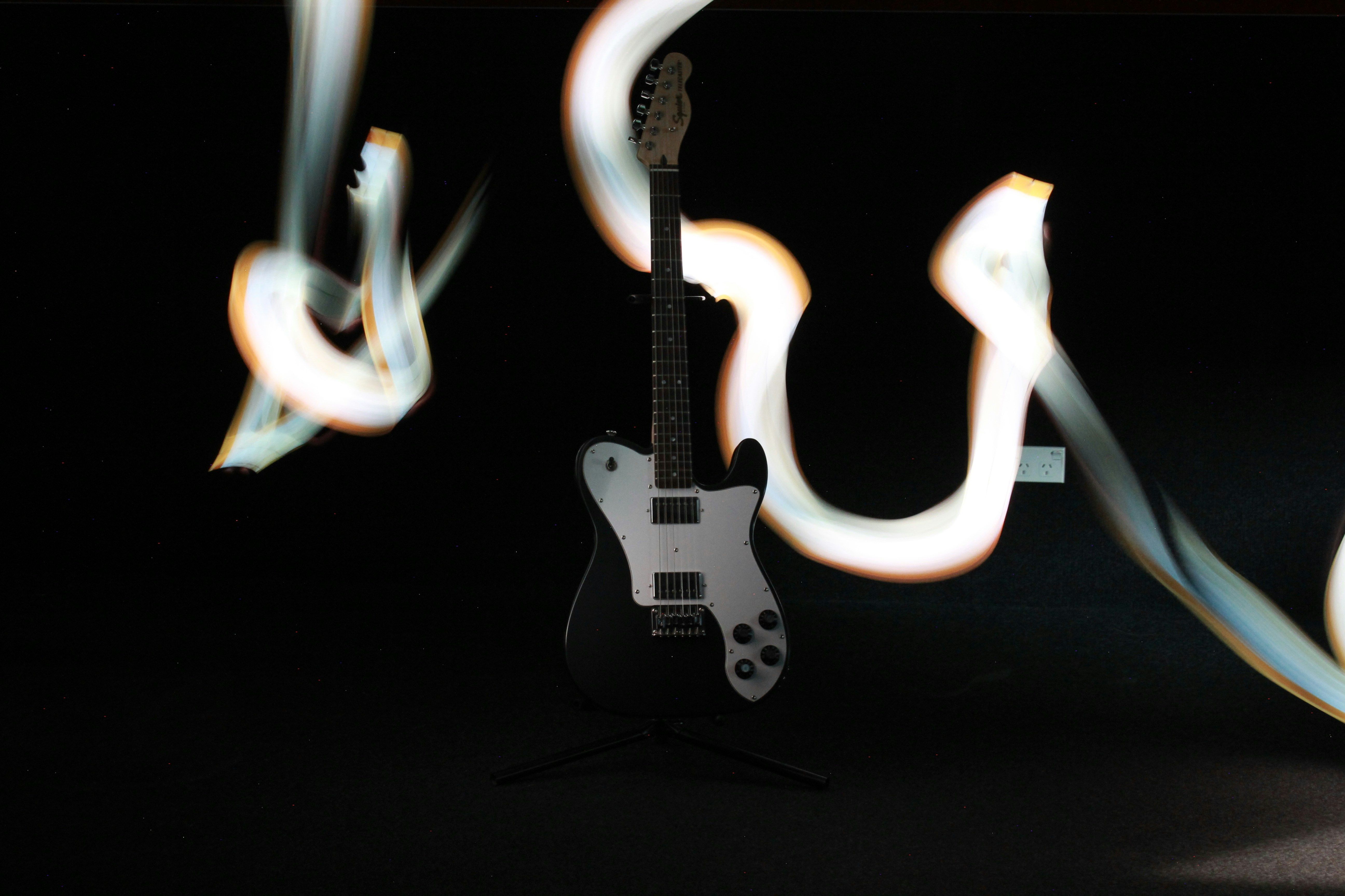 Neon Whirl: A Single-Edition Electric Guitar Surrounded by Ribbon Light