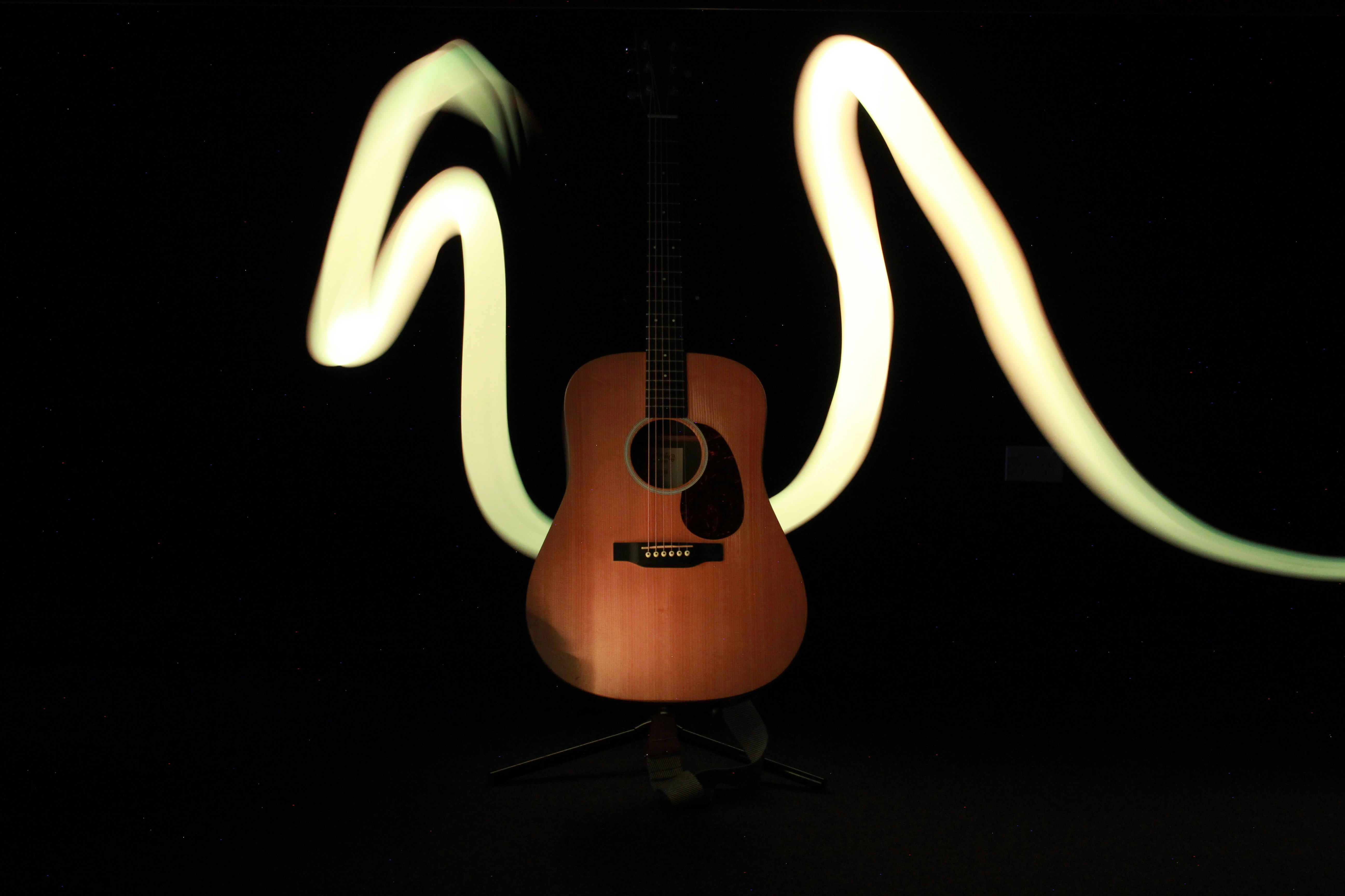 Guitar on a cradle of light, frozen in a nocturnal swirl
