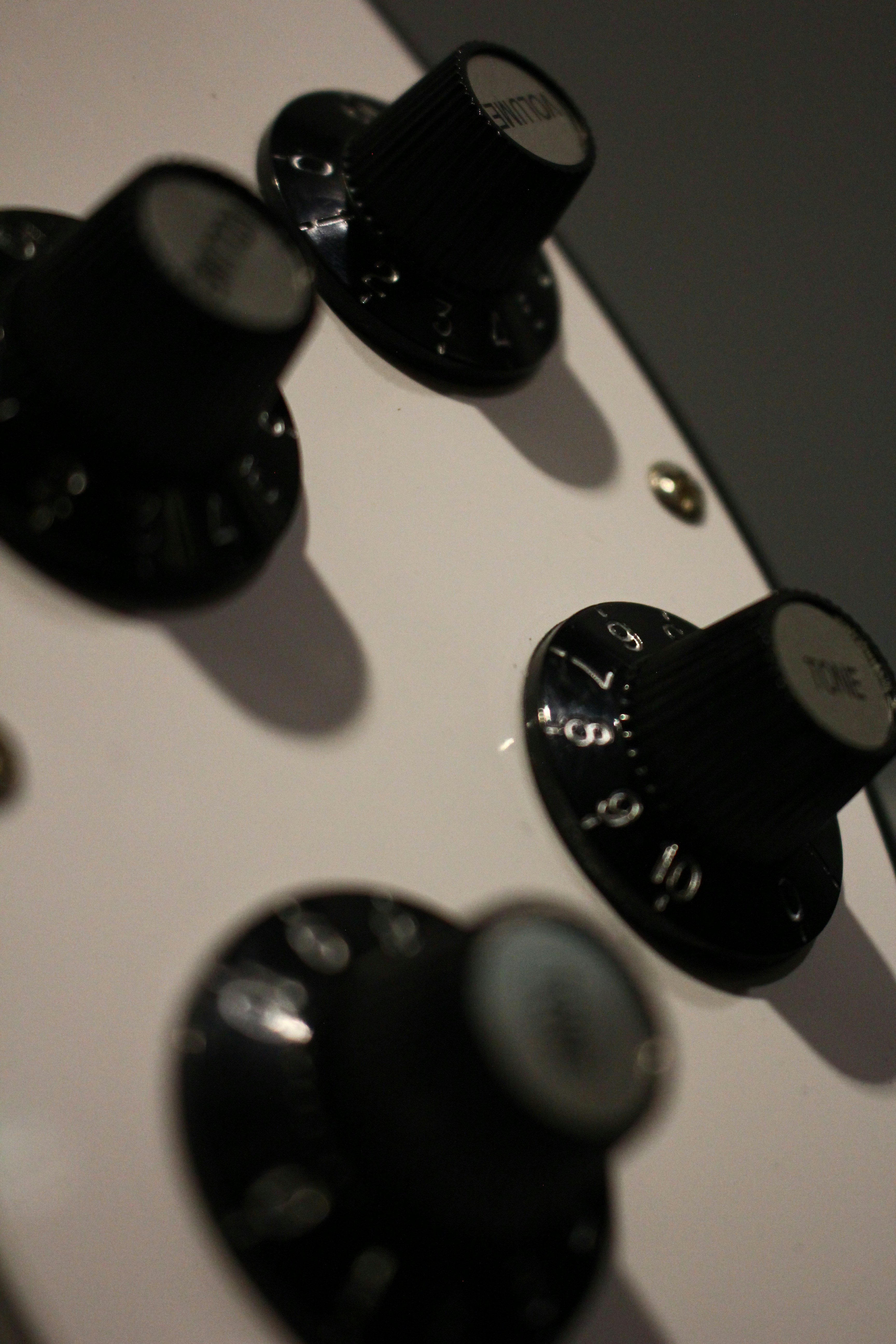 Close-Up of Guitar Mastery: Knobs in Focus