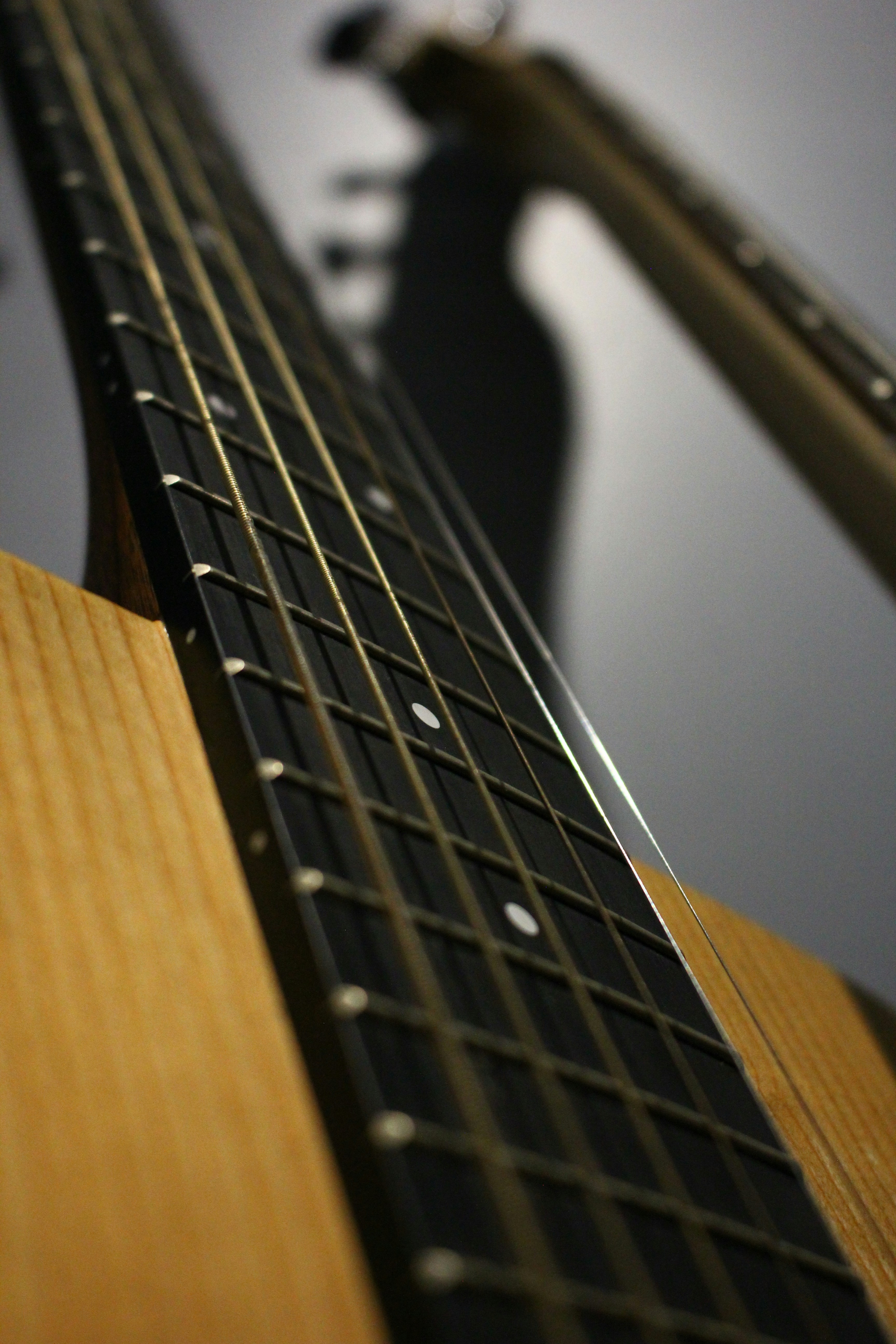 Close-up of an Acoustic Guitar Neck Reaching Toward the Camera