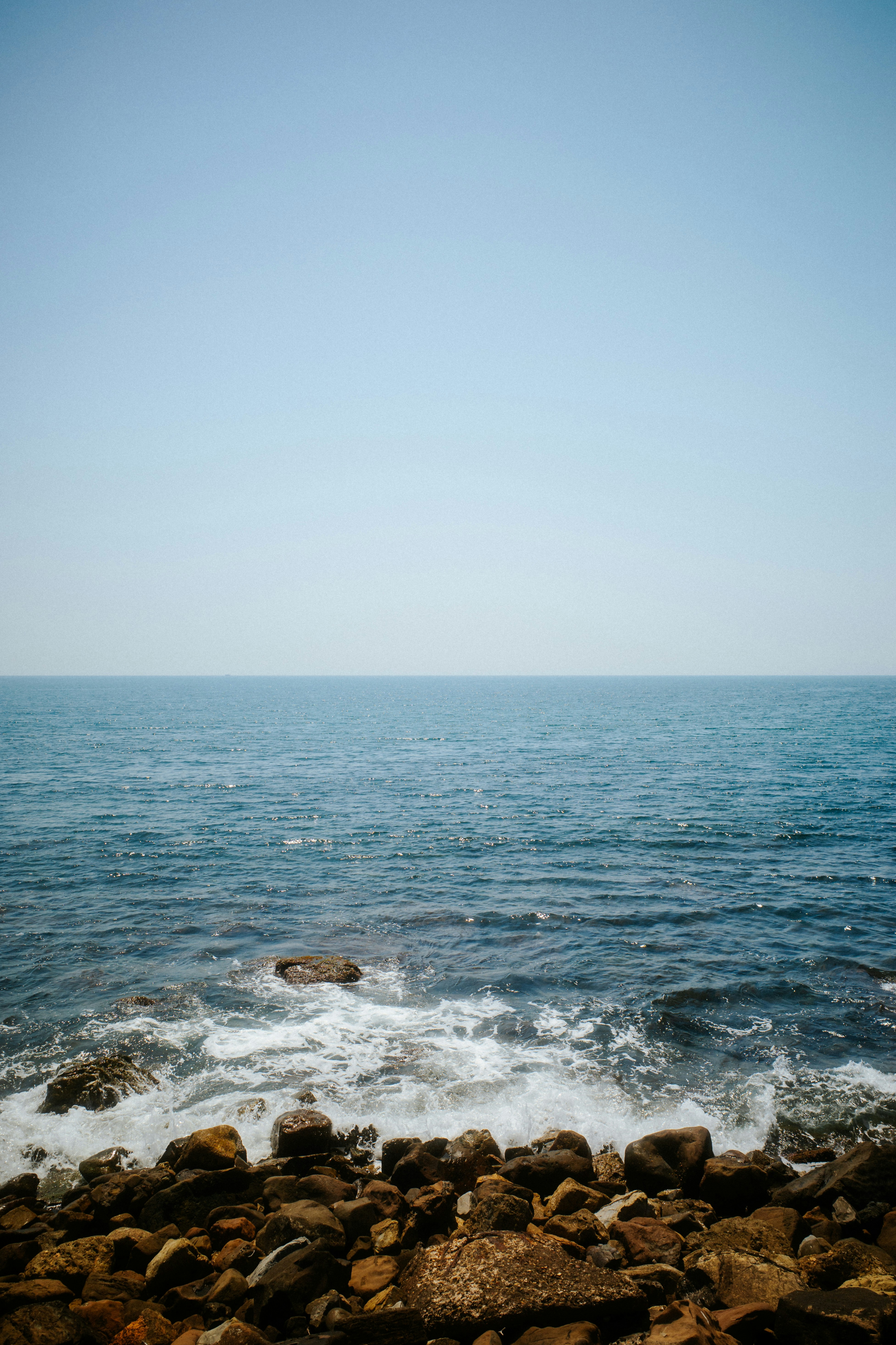 Coastline Quiet: Rocks Meet the Infinite Blue Horizon