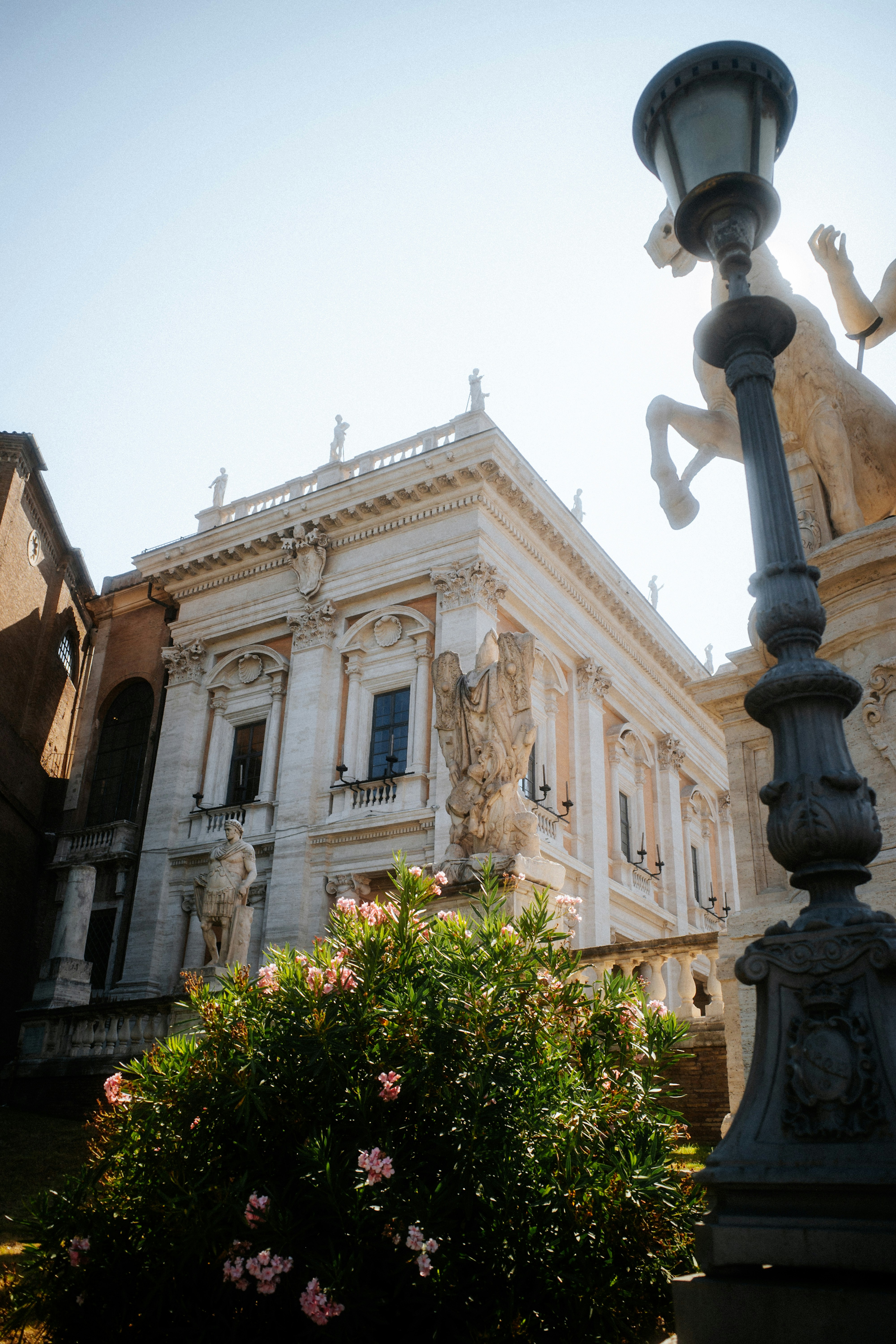 Sunlit Antiquity: Classical Facade framed by a Streetlamp
