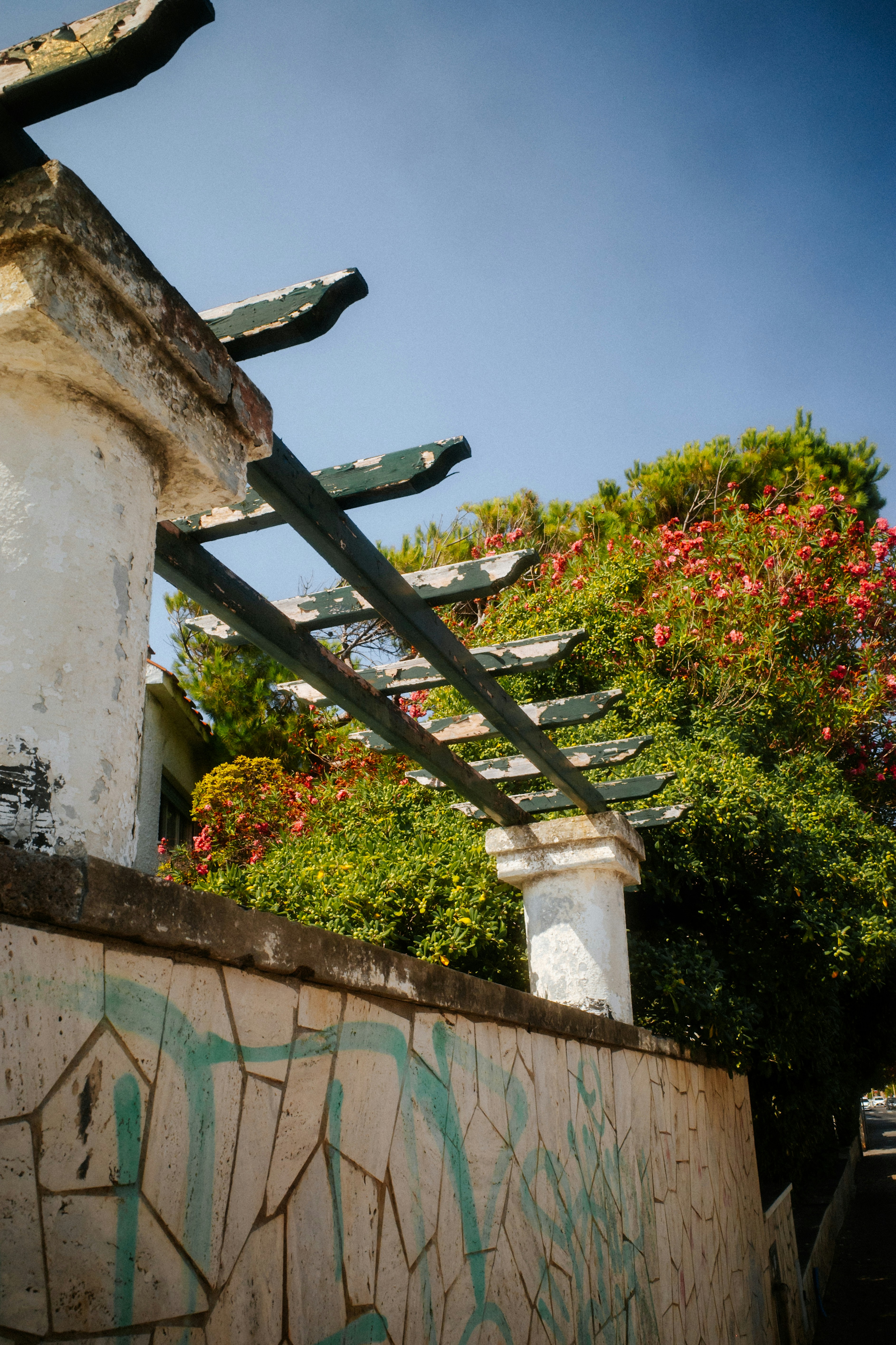 Graffiti Wall and Pergola Framing a Sunlit Sky