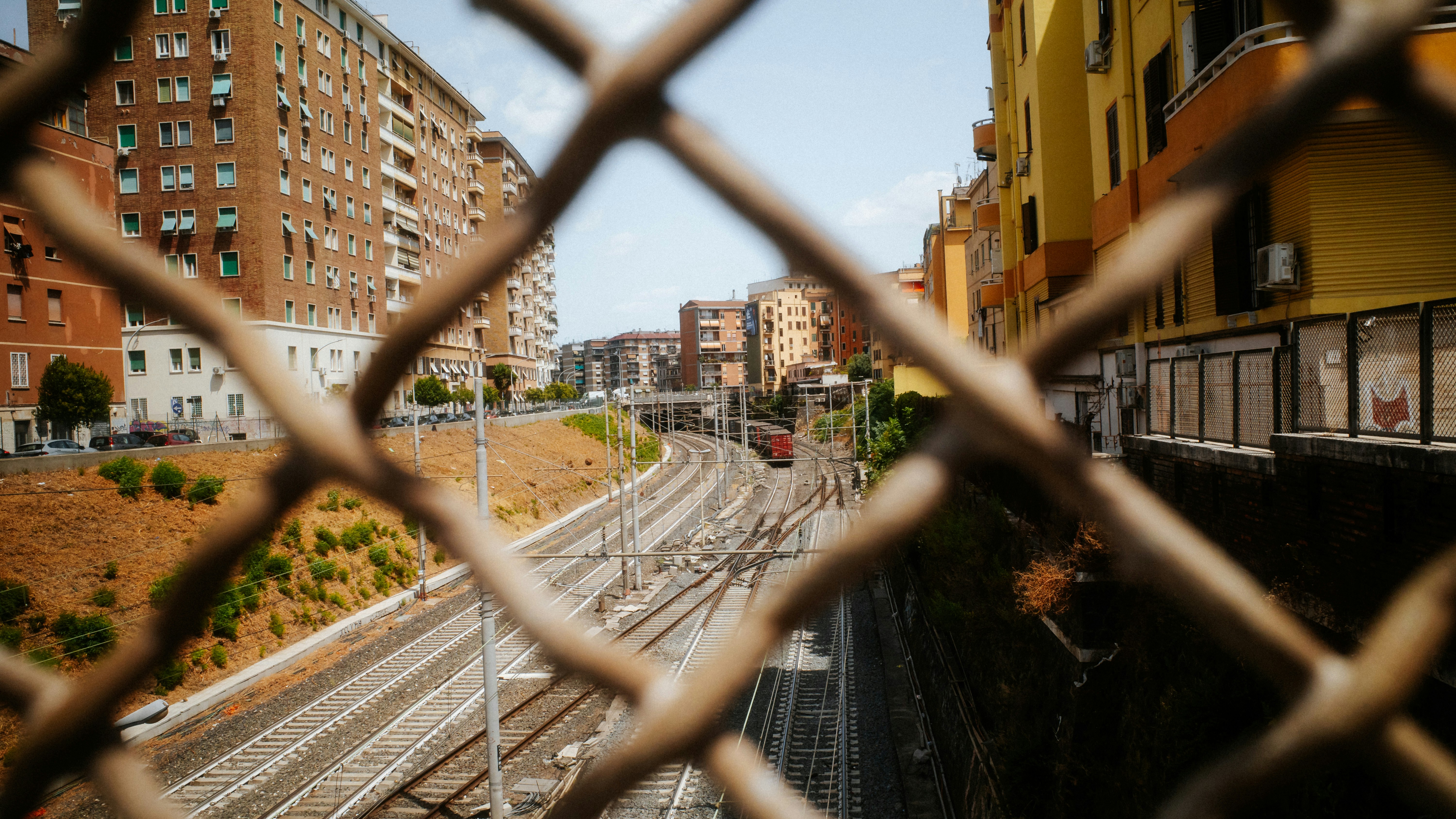 Through the Chain-link Corridor: City Rails Framing a Quiet Ascent