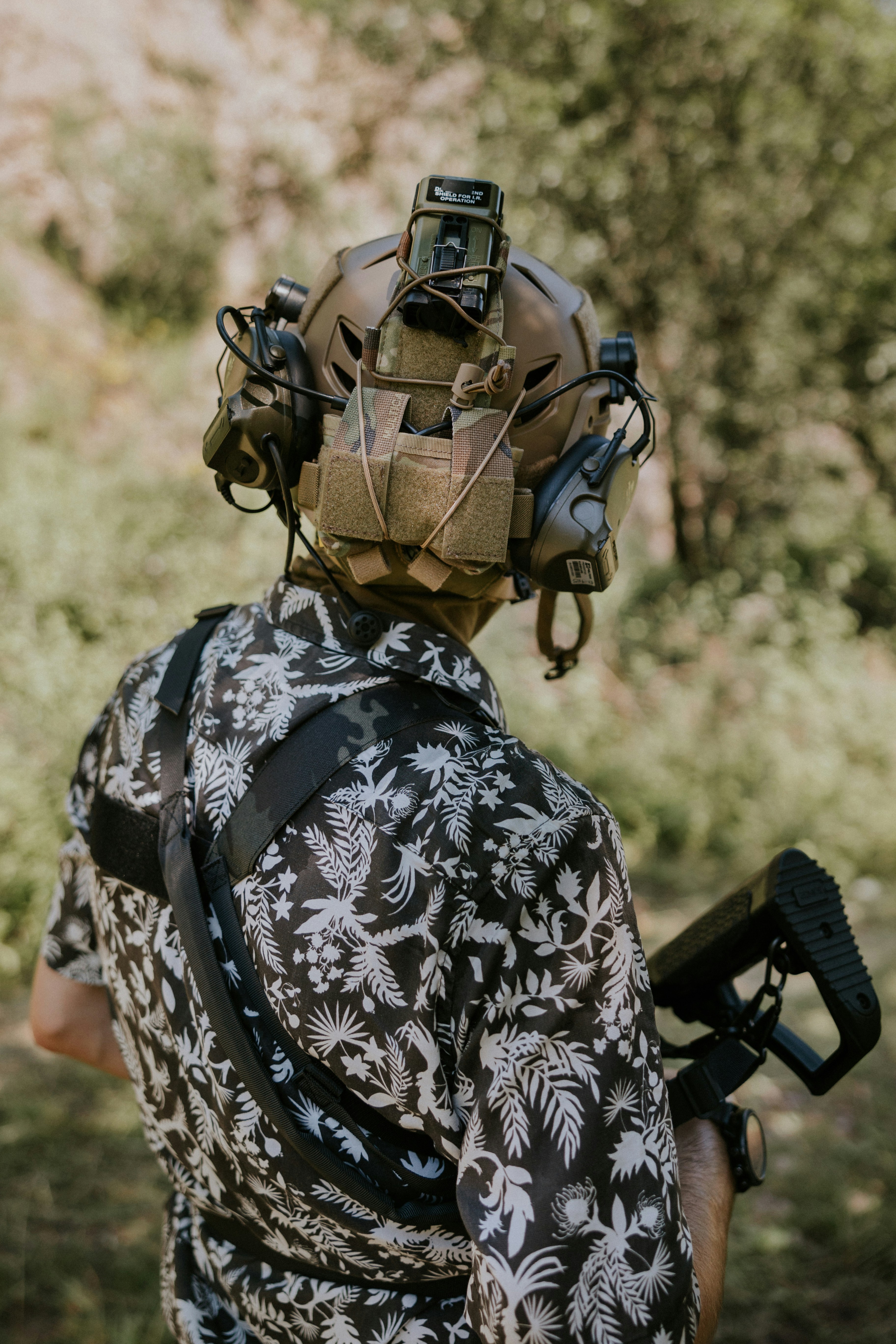 Tactical Portrait: Headset, Straps and Floral Shirt in Woods