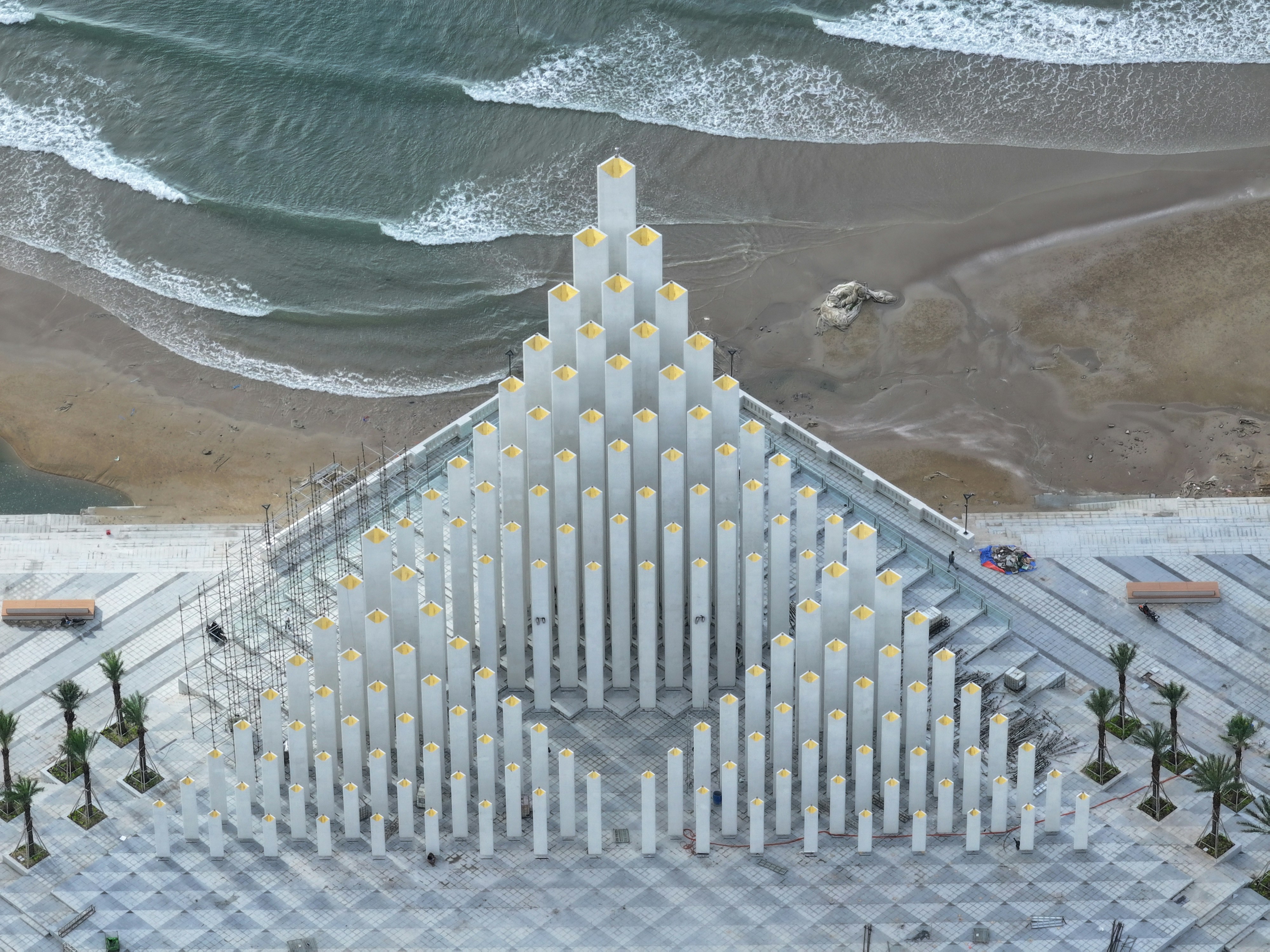 Symmetrical Sunrise: A Coastal Pyramid Reaching Toward the Sky