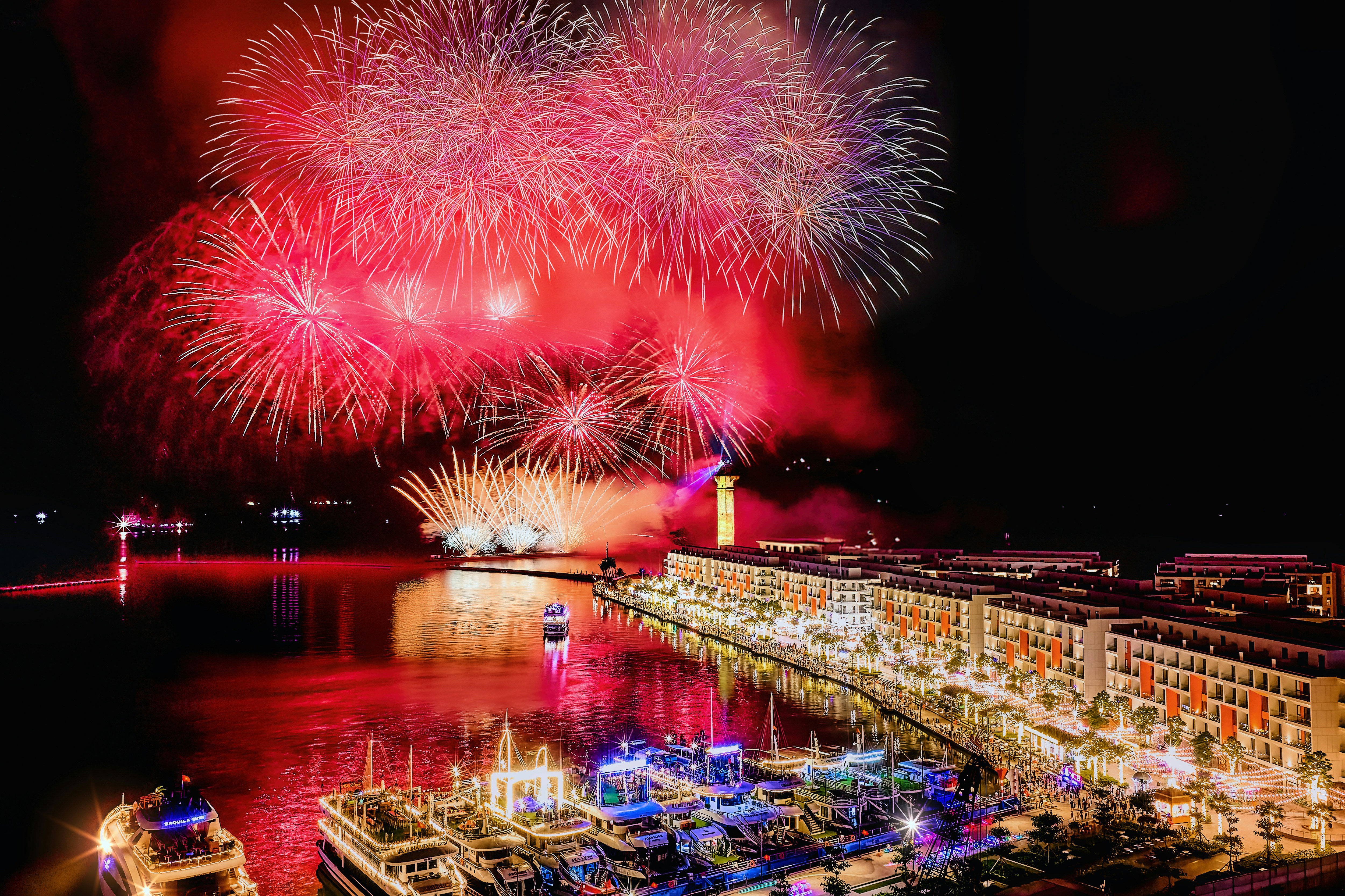 Harbor of Lights: Fireworks Over a Neon Marina