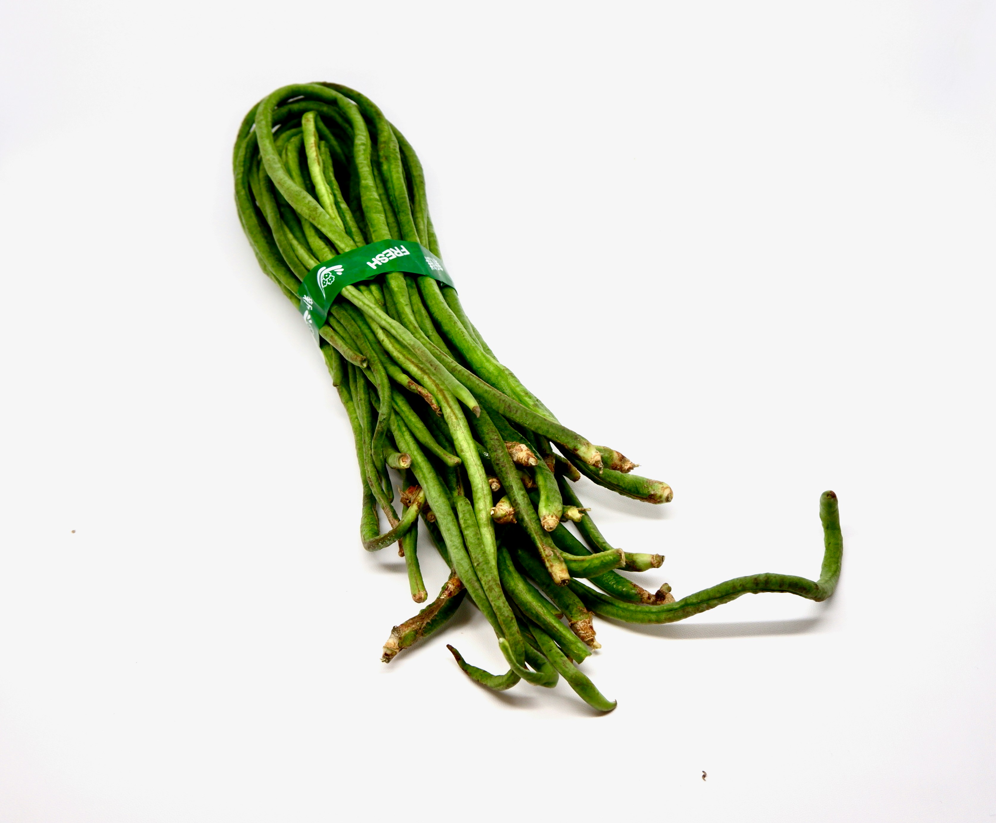 Verdant Tangle: Green Beans Bound with a Ribbon on a White Canvas